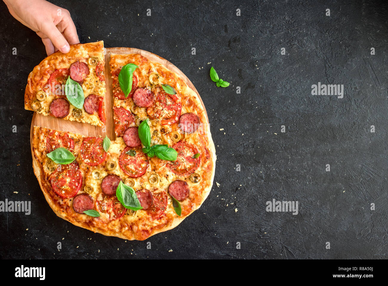 Hand taking pizza slice hi-res stock photography and images - Alamy