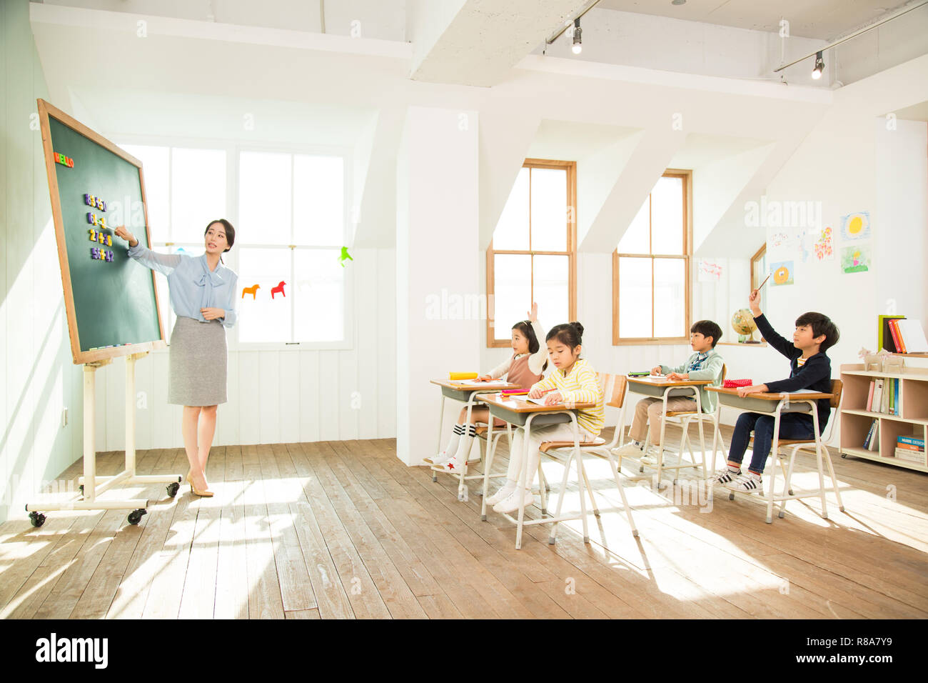 Young Students In Math Class With A Female Teacher Stock Photo - Alamy