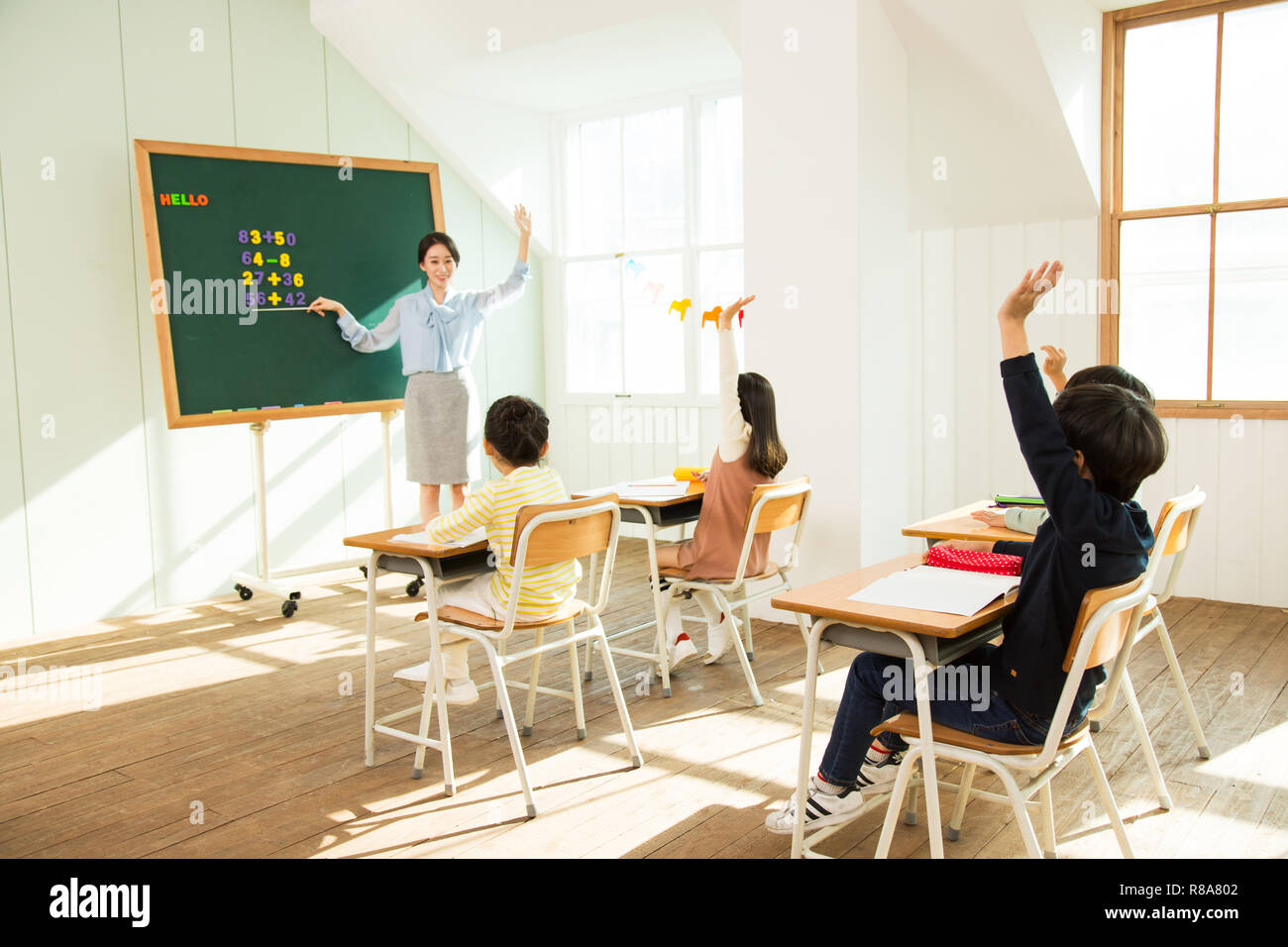 Young Students In Math Class With A Female Teacher Stock Photo - Alamy