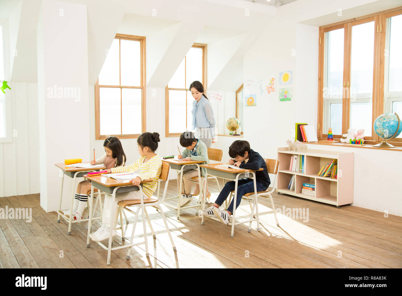 Female Teacher Keeping An Eye On Her Student Stock Photo - Alamy