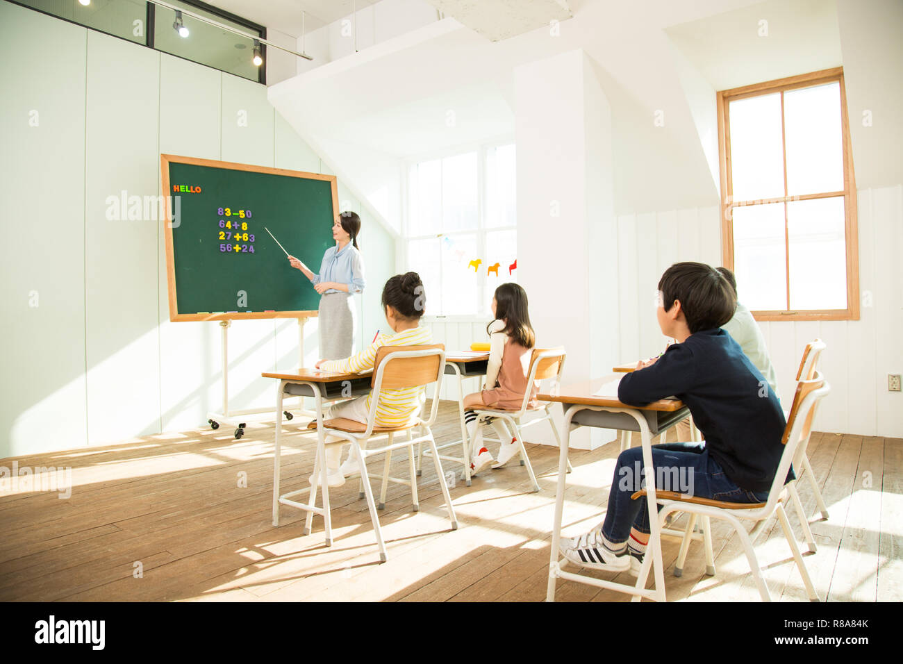 Female Teacher Teaching Math To Young Students Stock Photo - Alamy