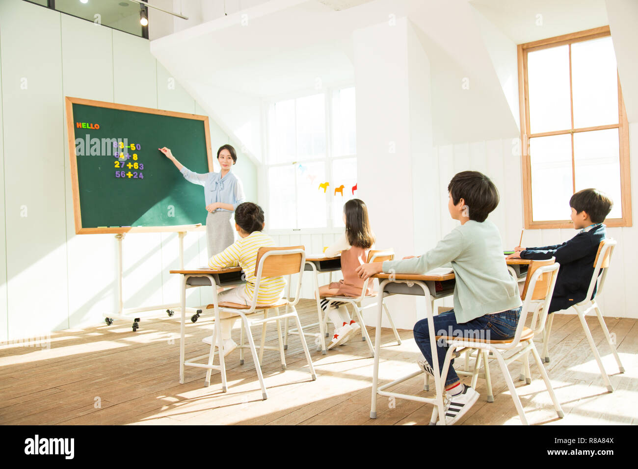 Female Teacher Teaching Math To Young Students Stock Photo - Alamy