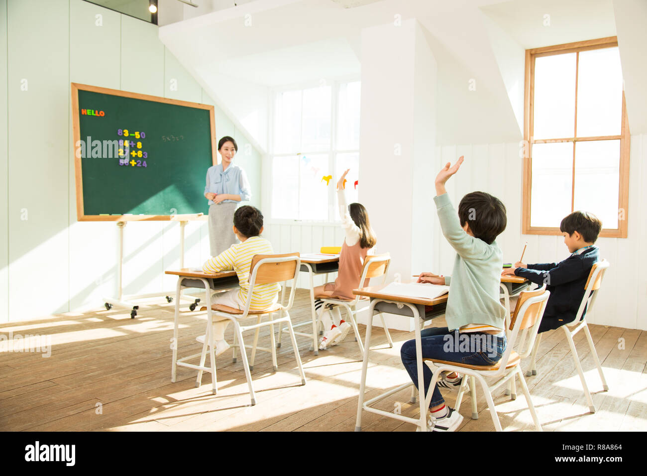 Female Teacher Teaching Math To Young Students Stock Photo - Alamy