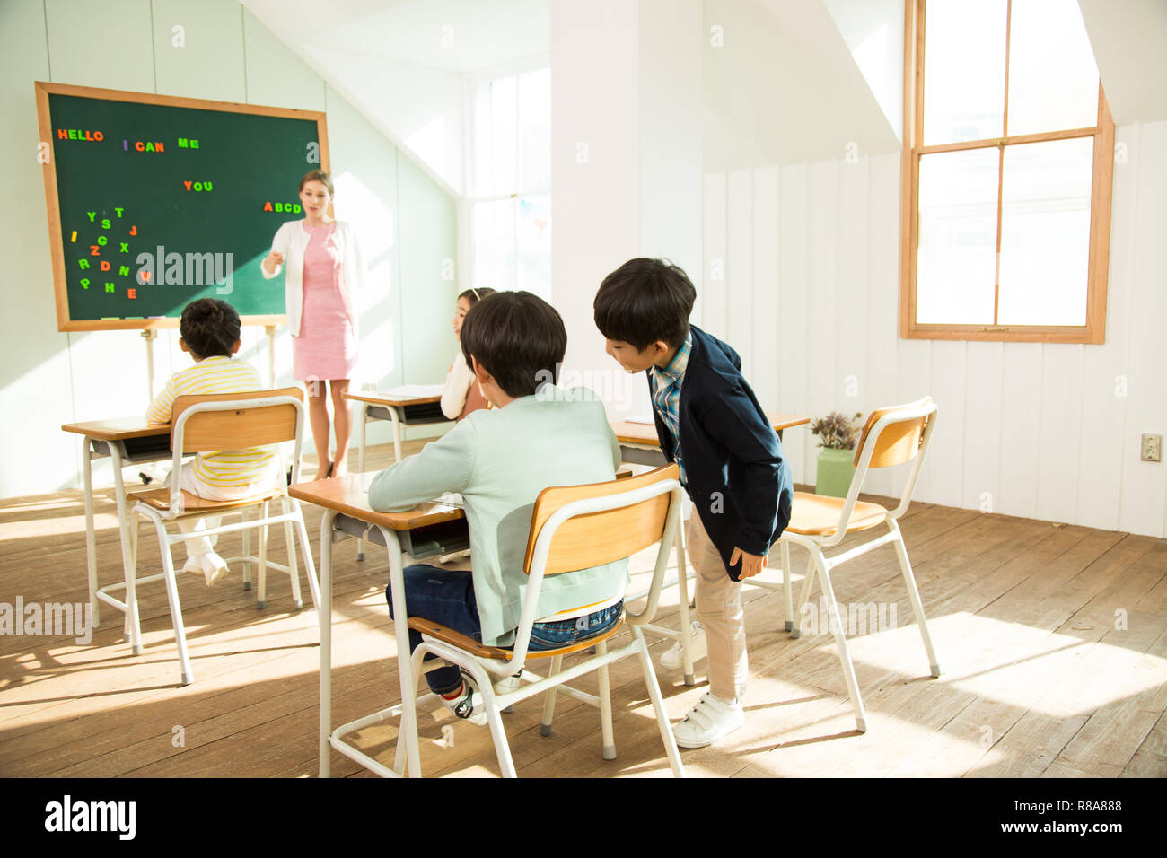 Female Teacher Teaching English To Young Students Stock Photo - Alamy
