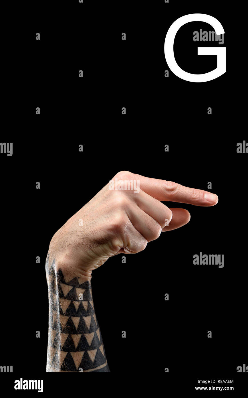 tattooed hand showing latin letter - G, sign language, isolated on ...