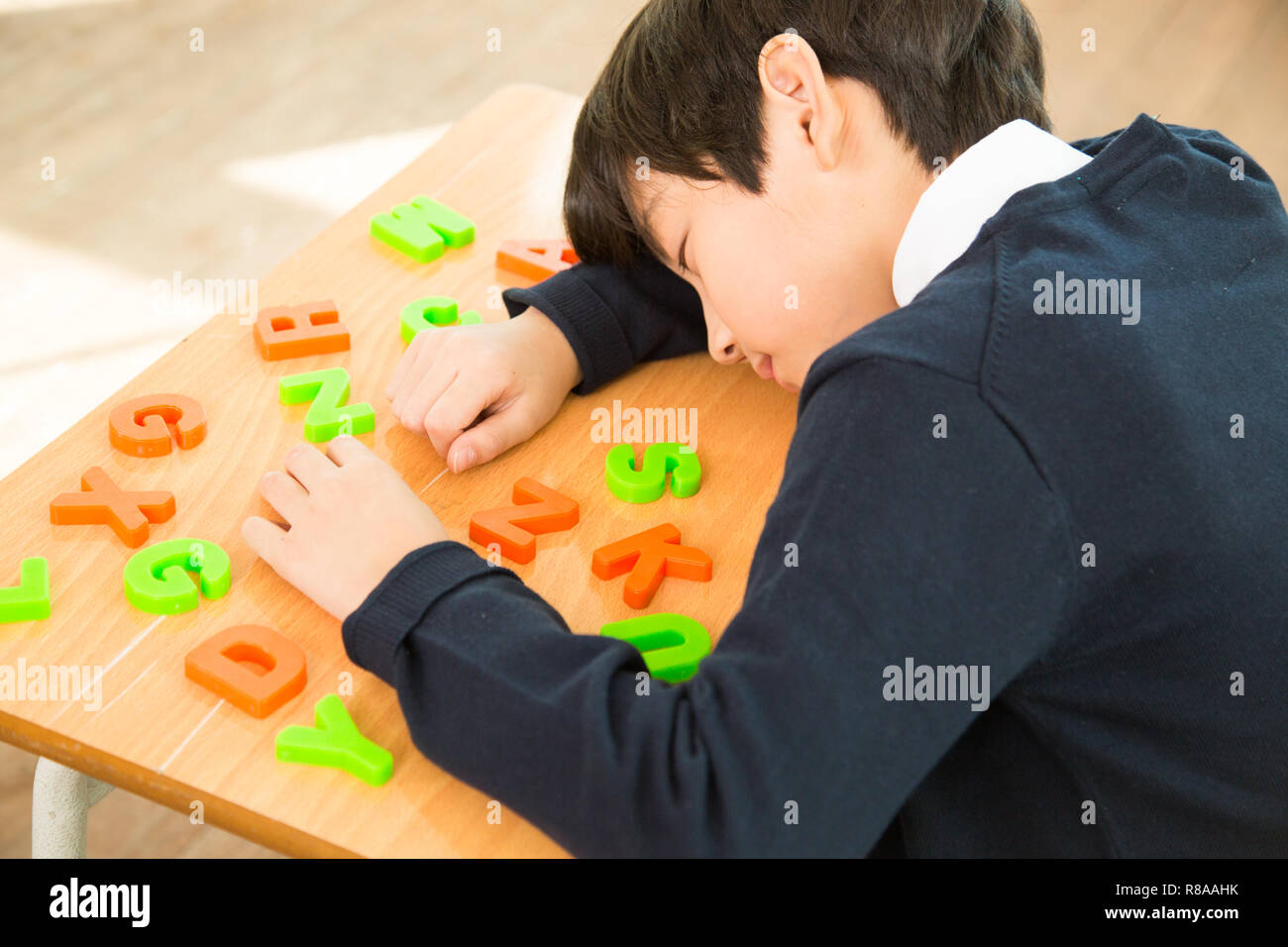 Sleeping kids on desk hi-res stock photography and images - Alamy