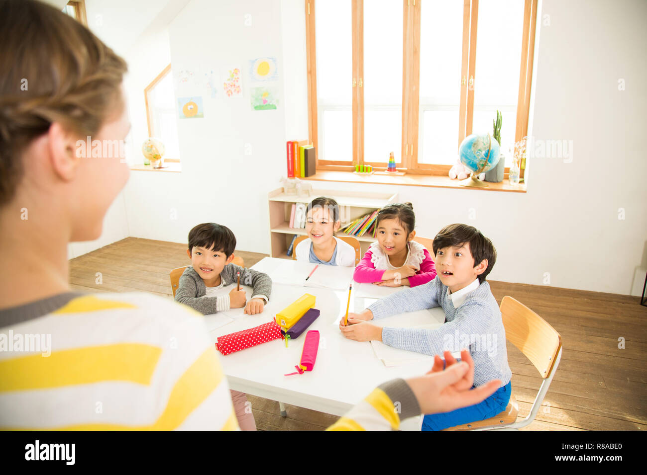 Young Students Learning With A Foreign Female Teacher Stock Photo - Alamy