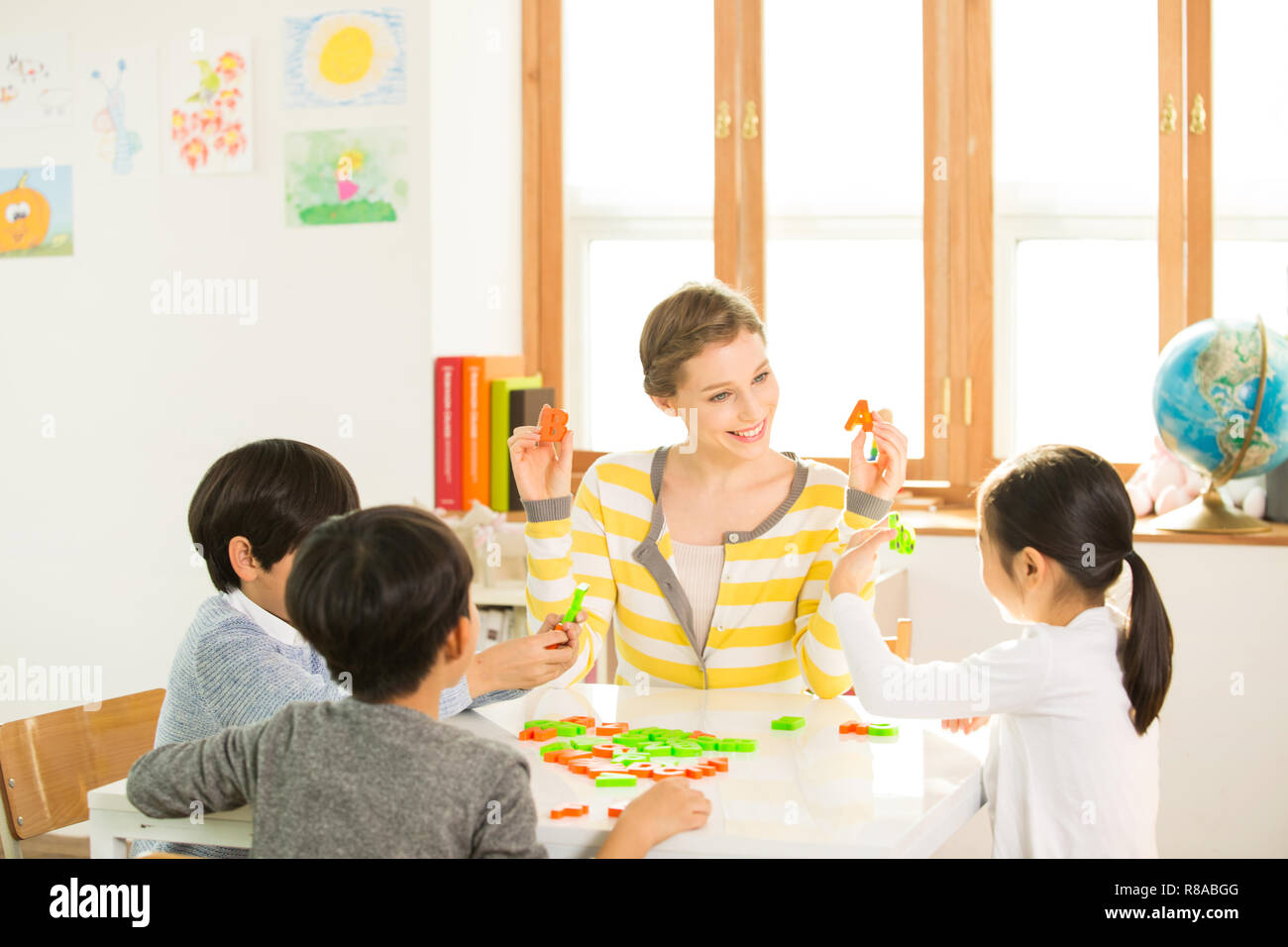 Young Students Learning English With A Foreign Female Teacher Stock ...
