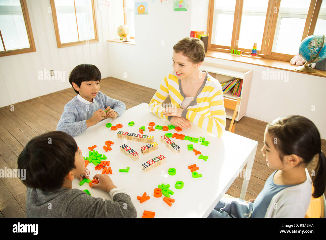 Young Students Learning English With A Foreign Female Teacher Stock ...