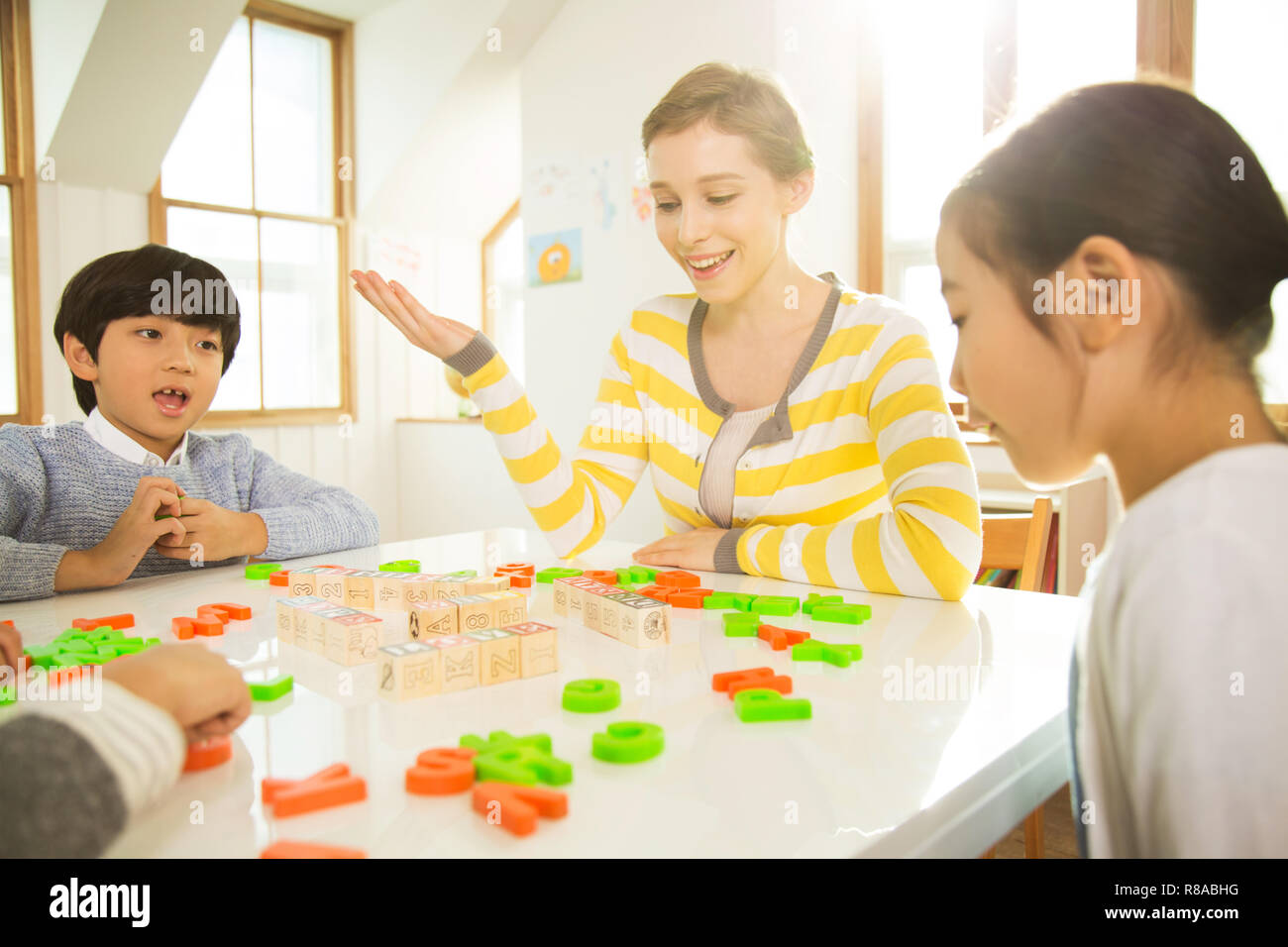 Young Students Learning English With A Foreign Female Teacher Stock ...
