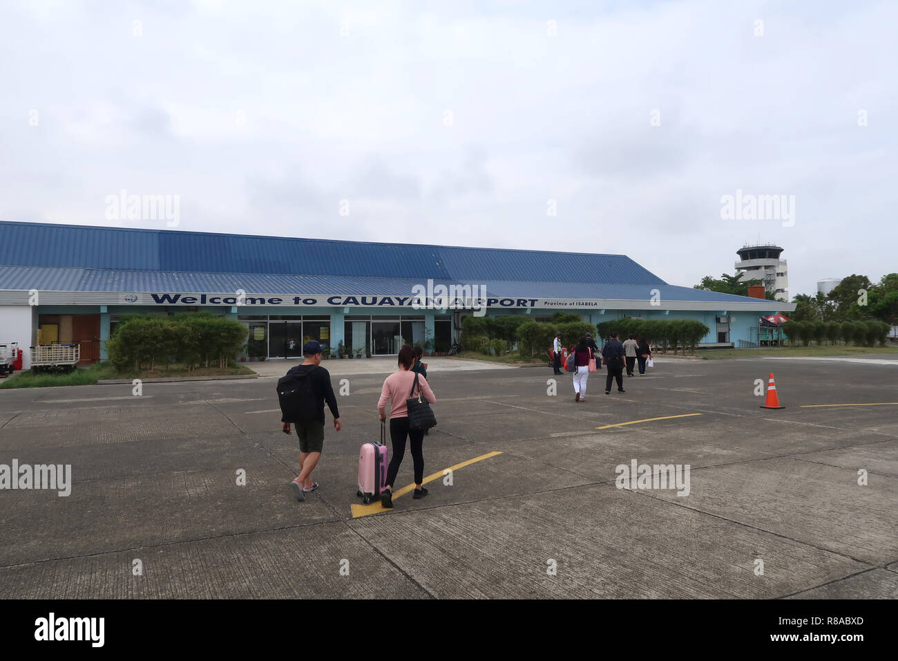 Passengers on their way to the terminal of Cauayan Airport after ...