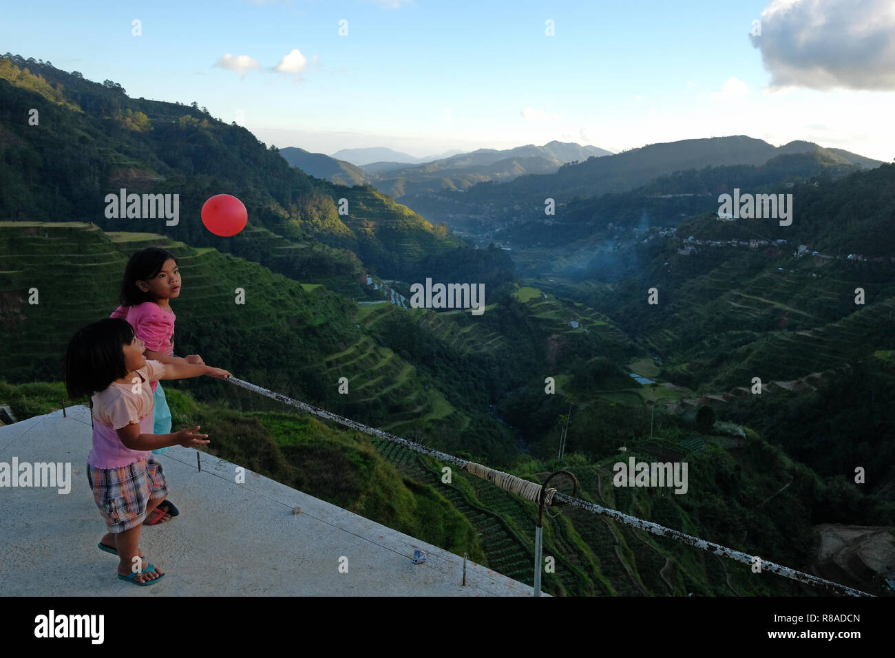 Young Filipino girls playing on a view deck overlooking the Banaue Rice ...