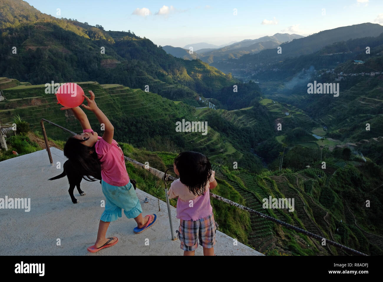 Young Filipino girls playing on a view deck overlooking the Banaue Rice ...