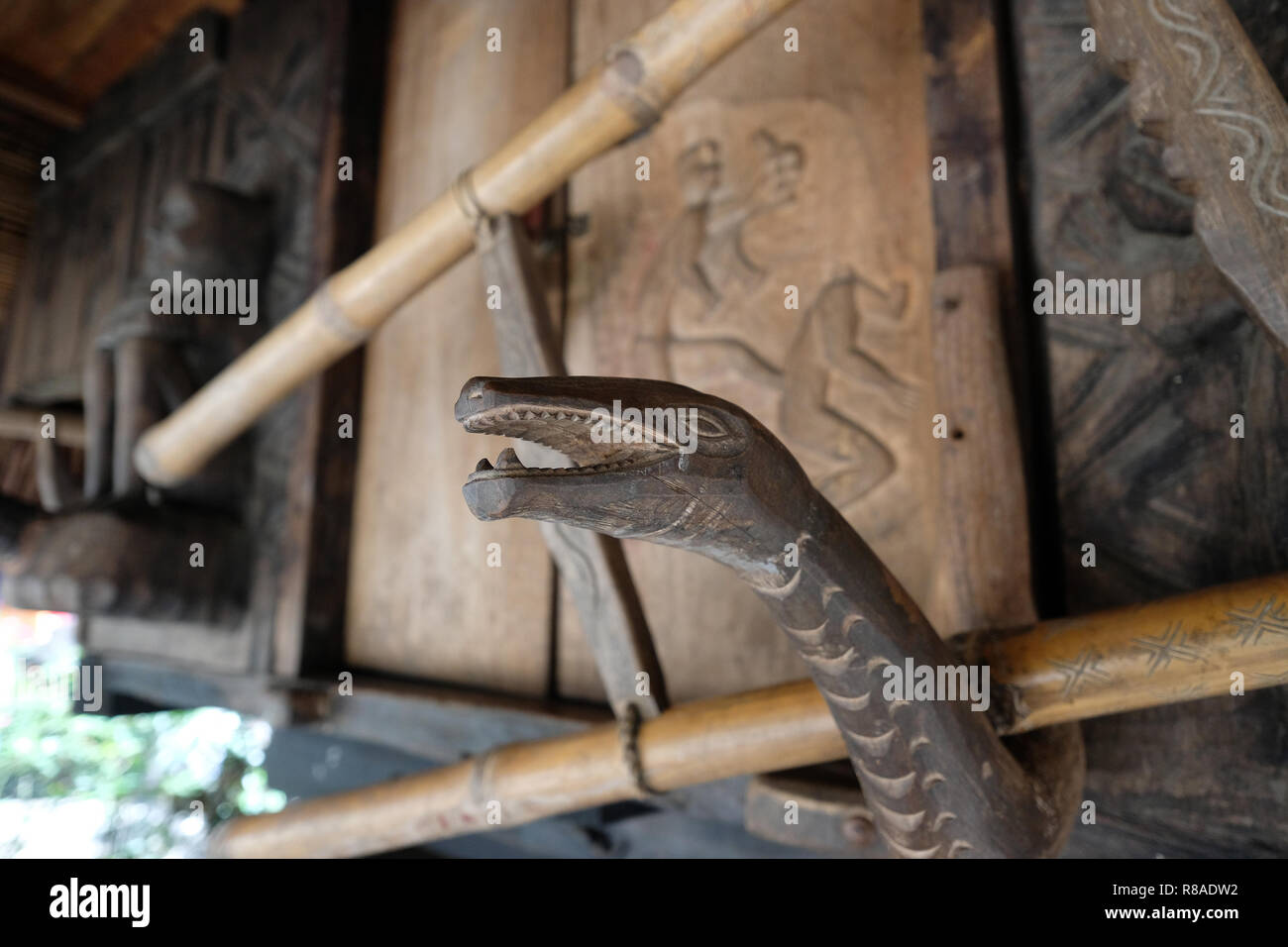 Carved wooden figures decorating a traditional native house of the ...