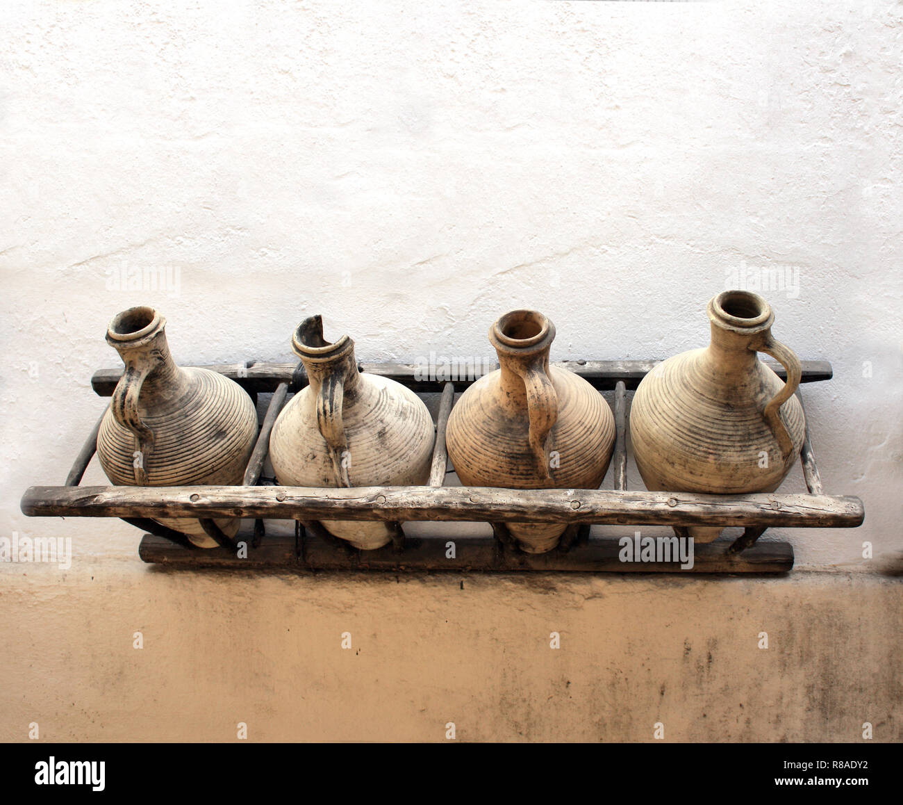 Ancient pitchers on stucco wall Stock Photo - Alamy