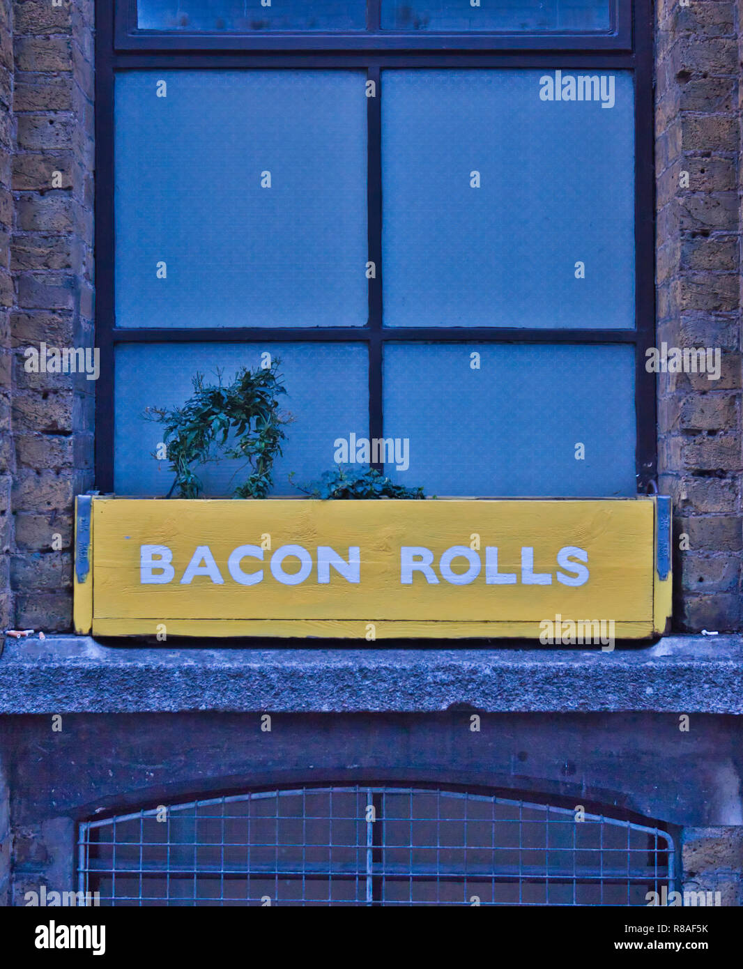 Bacon rolls painted on yellow window box, London, England Stock Photo ...