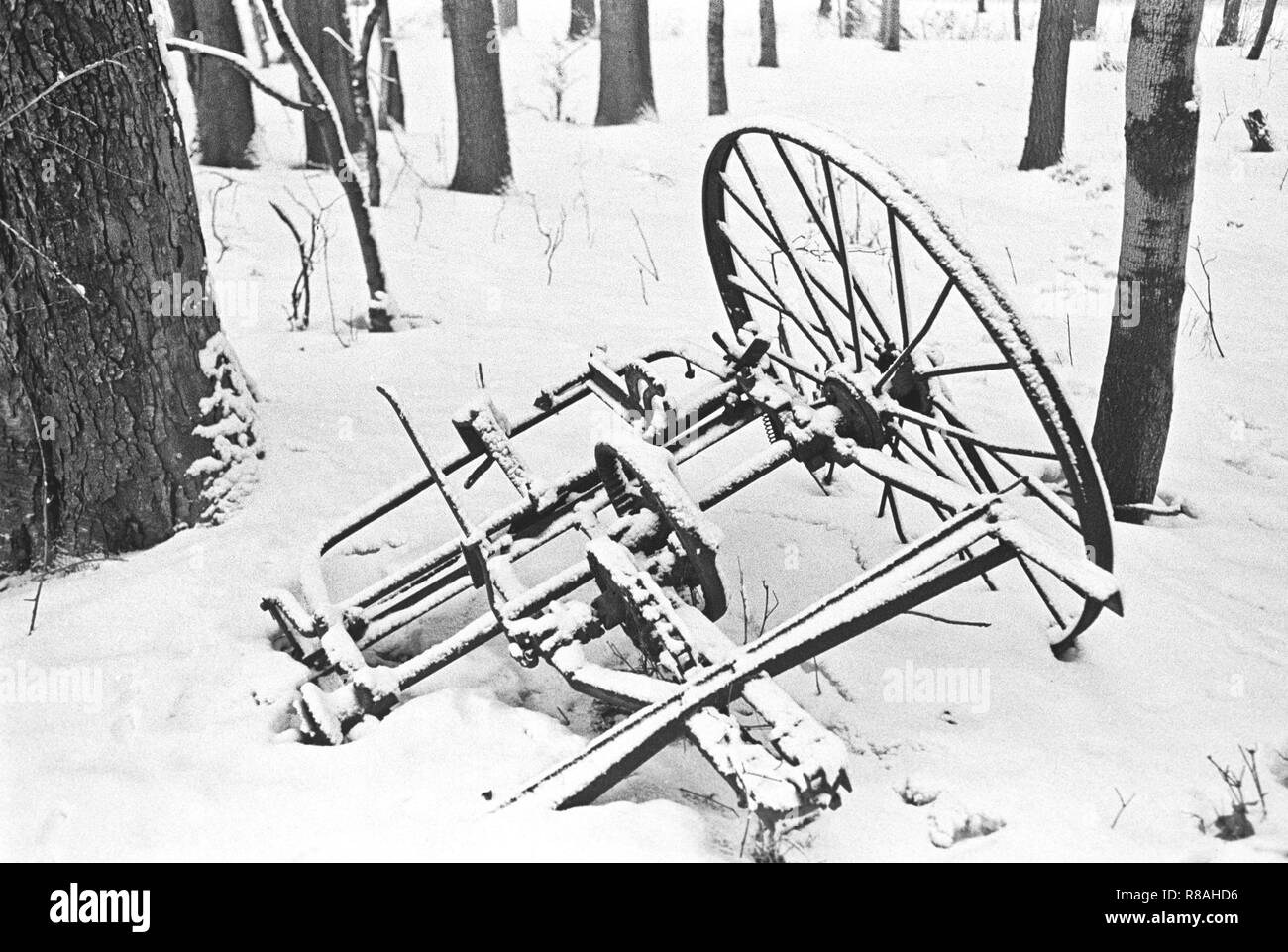 History-steeped agricultural equipment on a snow-covered field of the ...