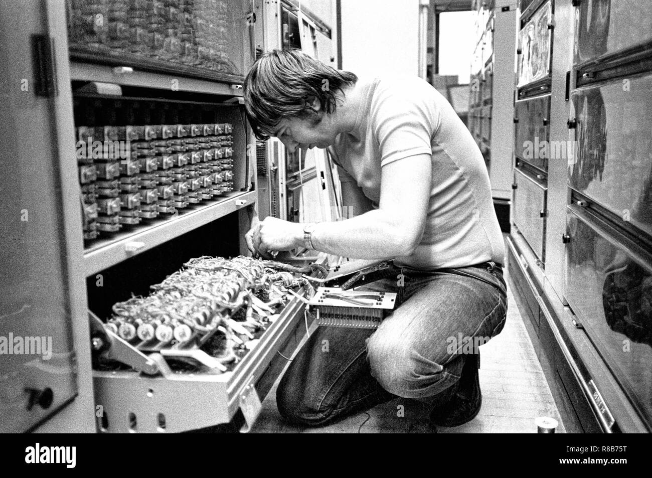 An engineer doing a modification to a crossbar switch in a crossbar ...