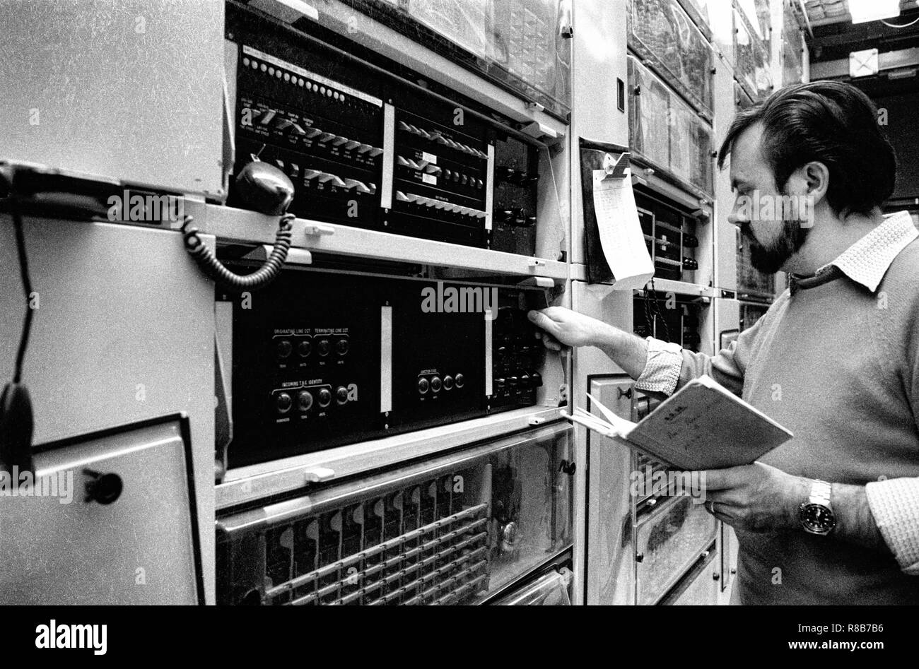 An engineer setting up a "register sender" test machine in a crossbar ...