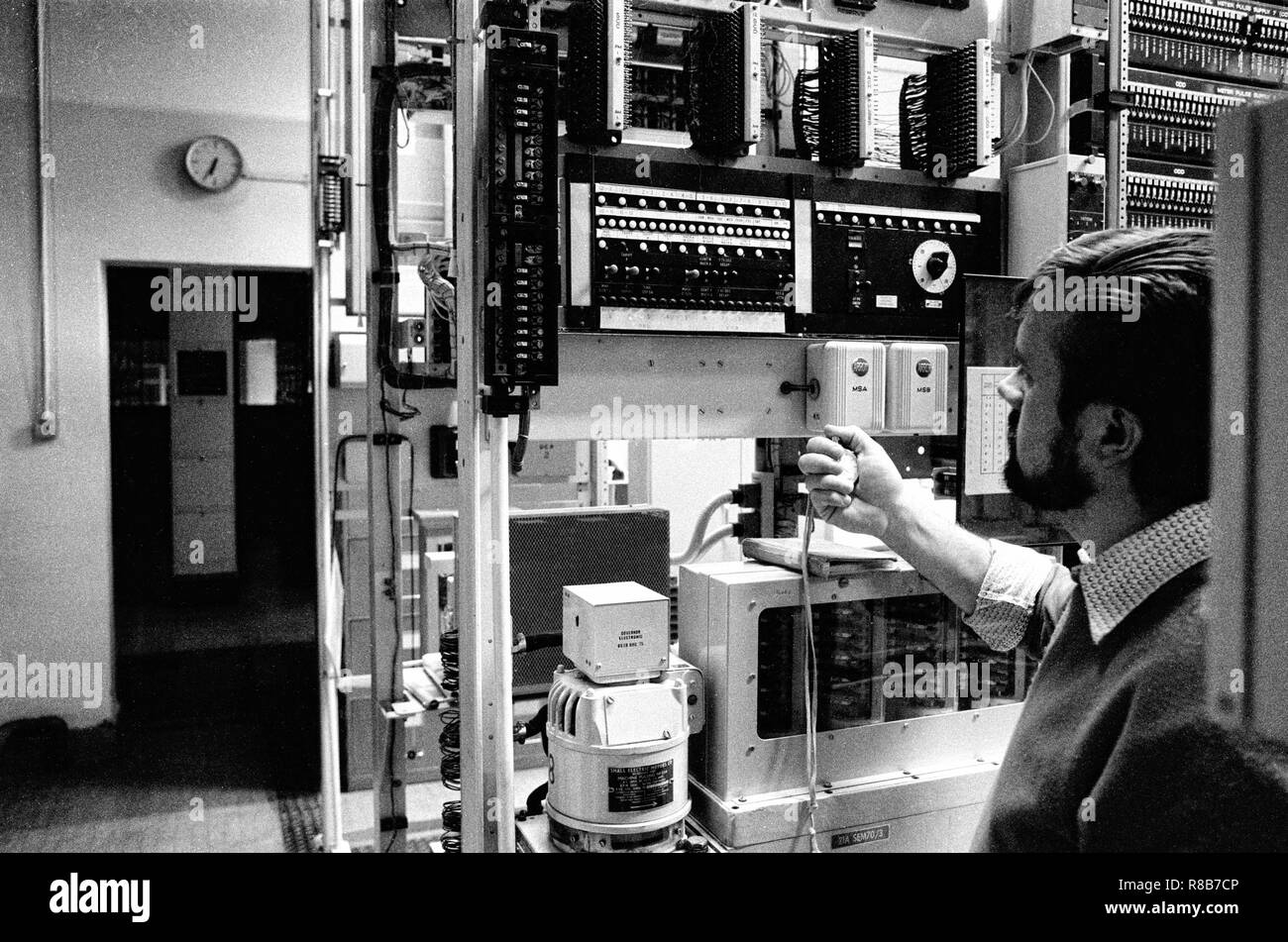 An engineer checking the meter pulse supply in a crossbar telephone ...