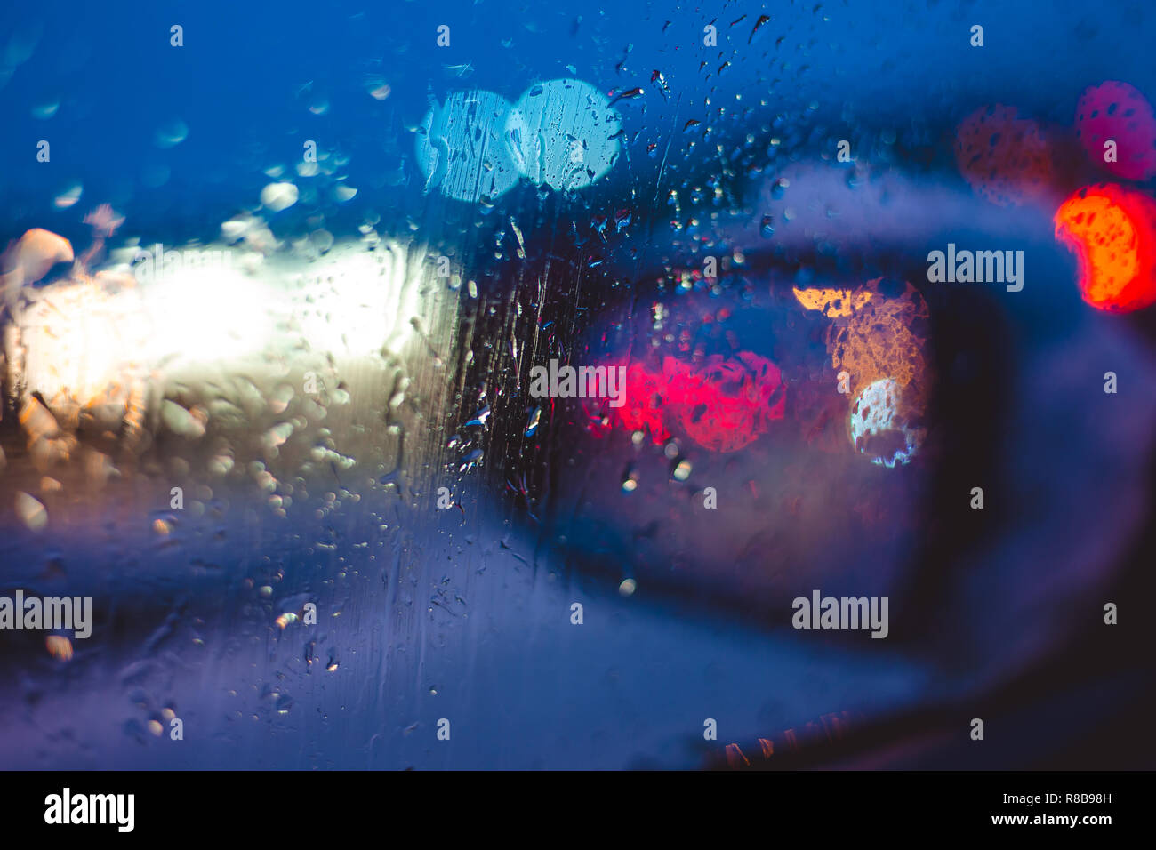 Night city road through windshield cars abstract background water drop ...