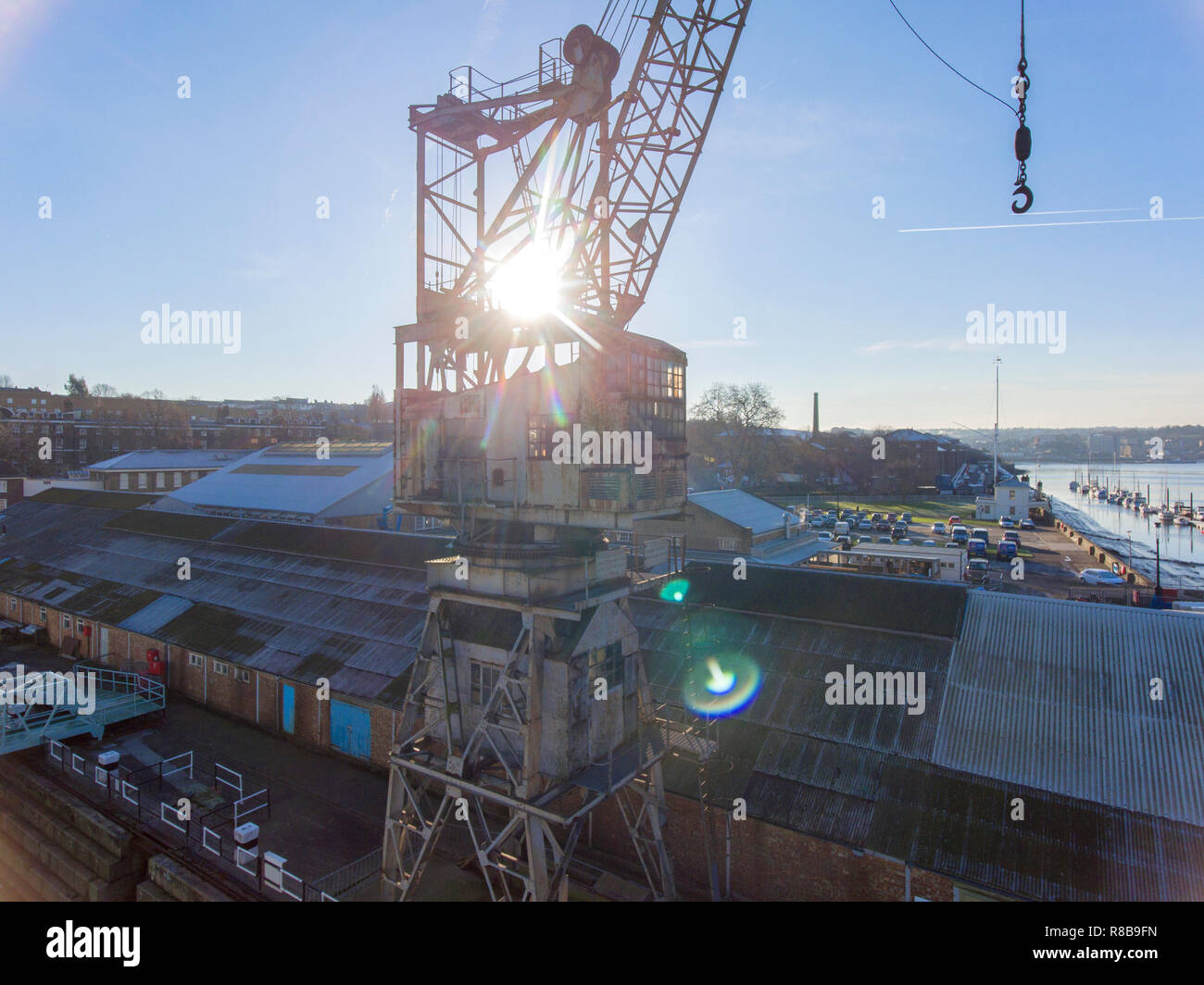 Dockside crane lit by early morning sun at Chatham Historic Dockyard ...