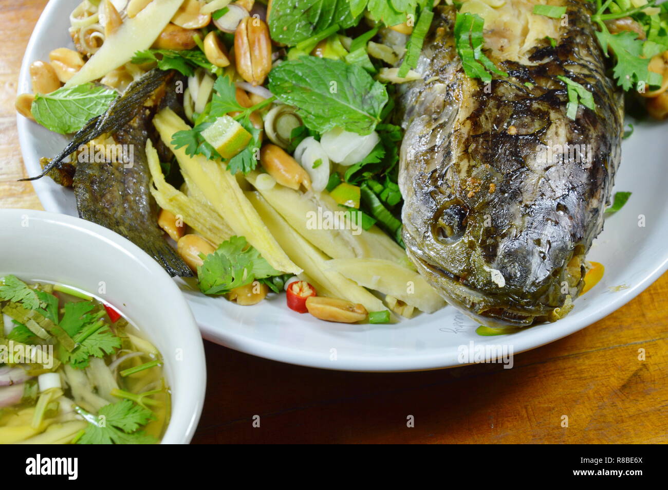 deep fried snake head fish with mixed herb dipping sweet sauce Stock ...