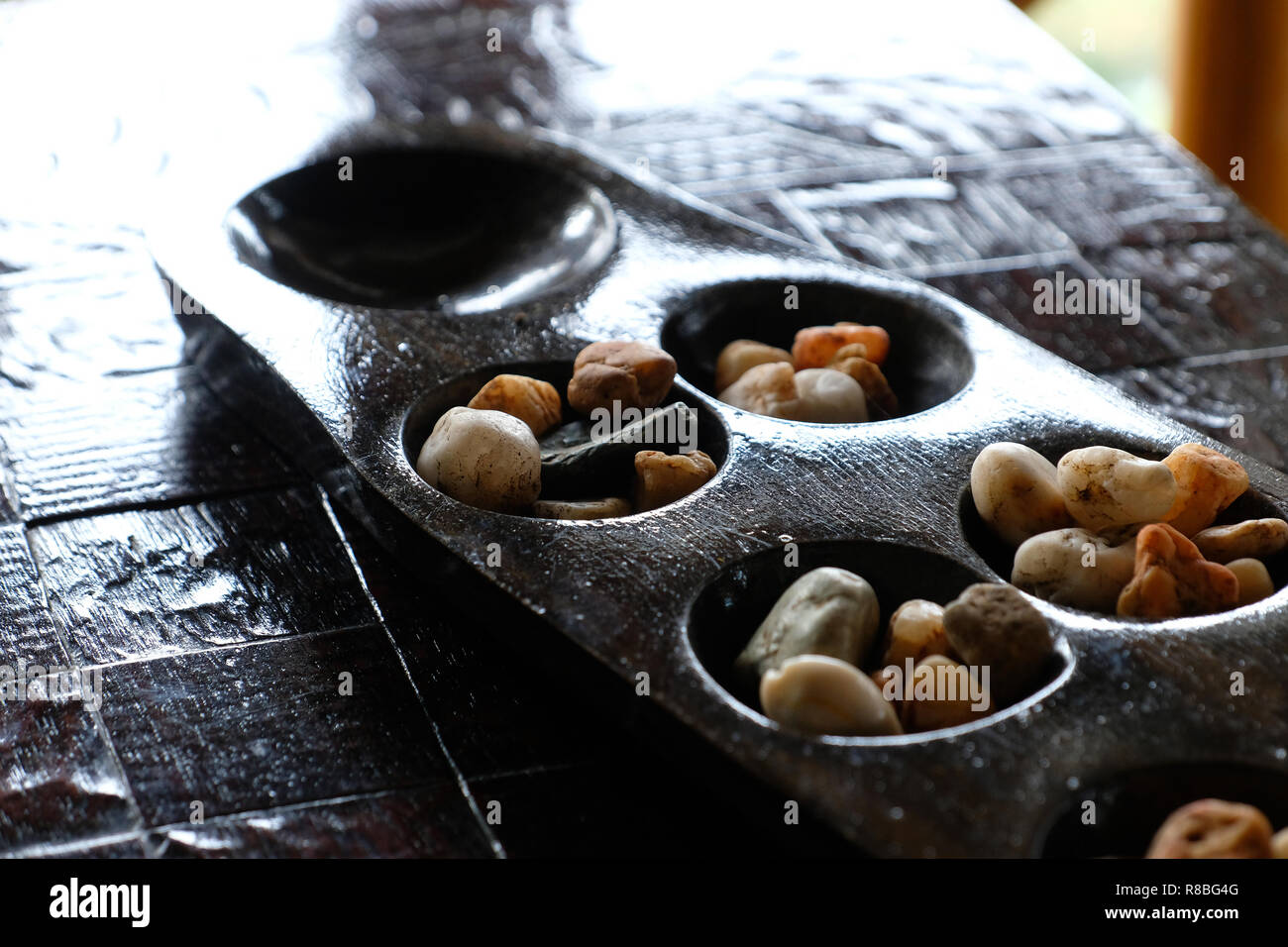 A Philippine mancala strategy board games named Sungka which involves ...