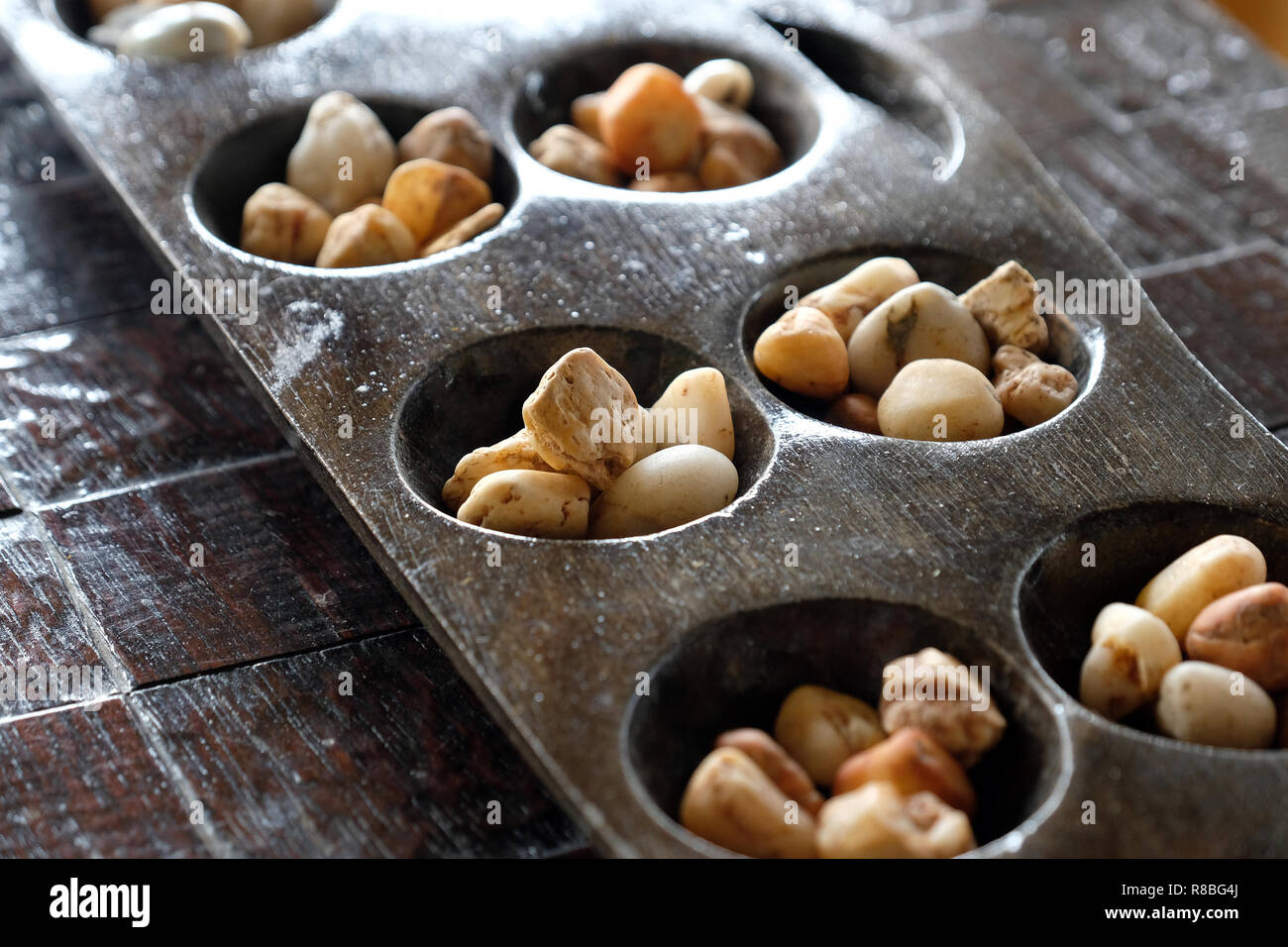 A Philippine mancala strategy board games named Sungka which involves ...