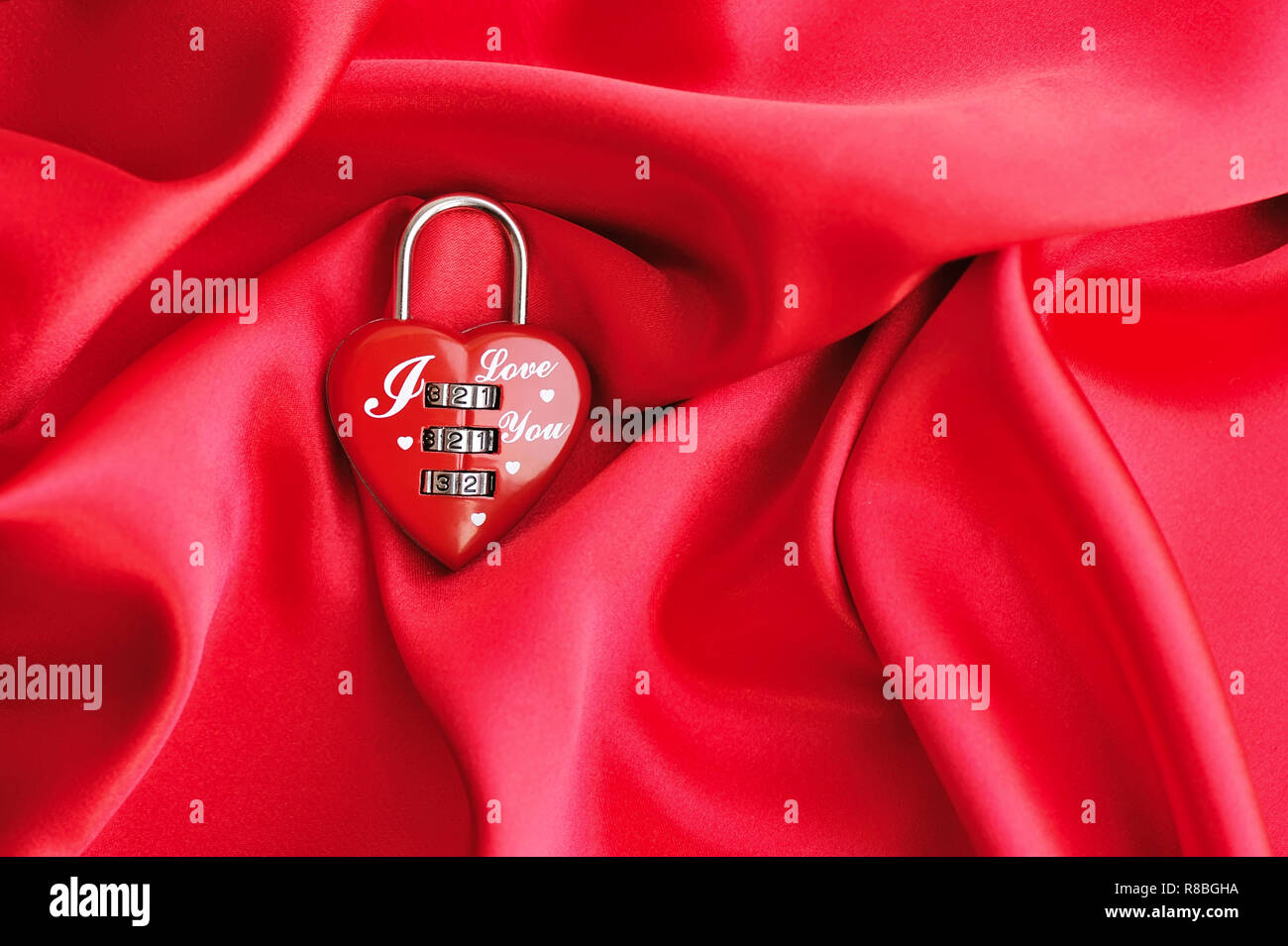 Padlock heart-shape on satin fabric background Stock Photo - Alamy