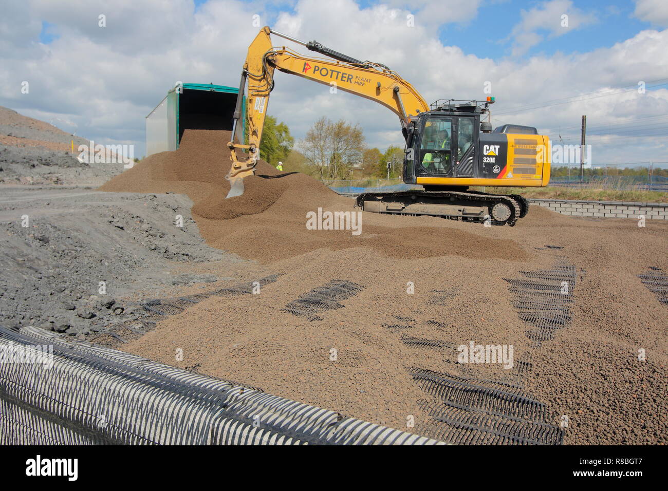 A Caterpillar 320E levelling out lightweight expanded clay aggregate ...