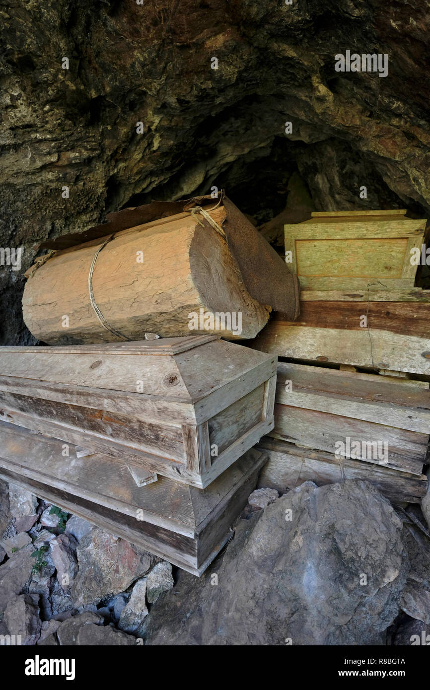 Pile of pine caskets, some hundreds of years old placed in small caves ...