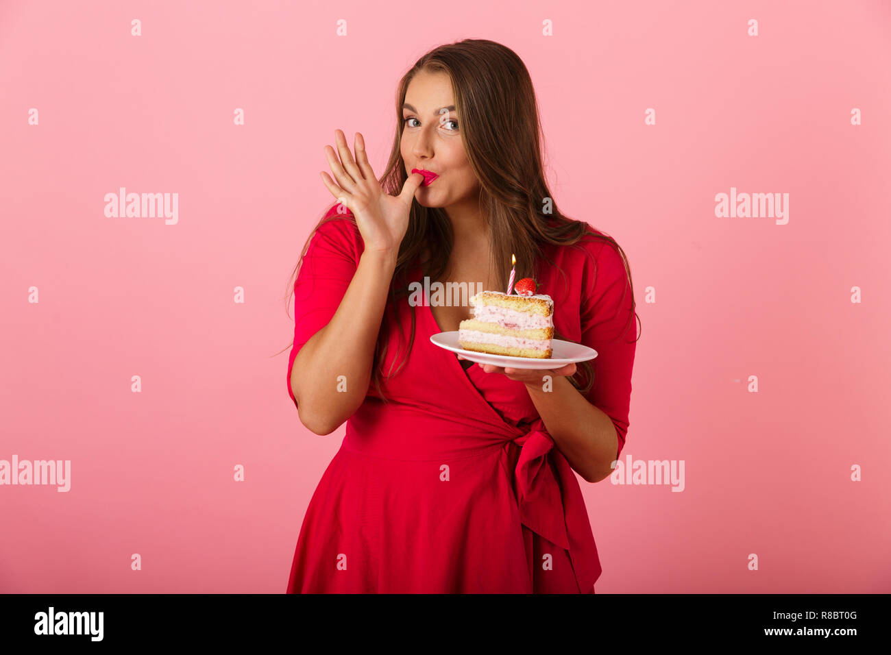 Image of an excited hungry young woman isolated over pink wall ...