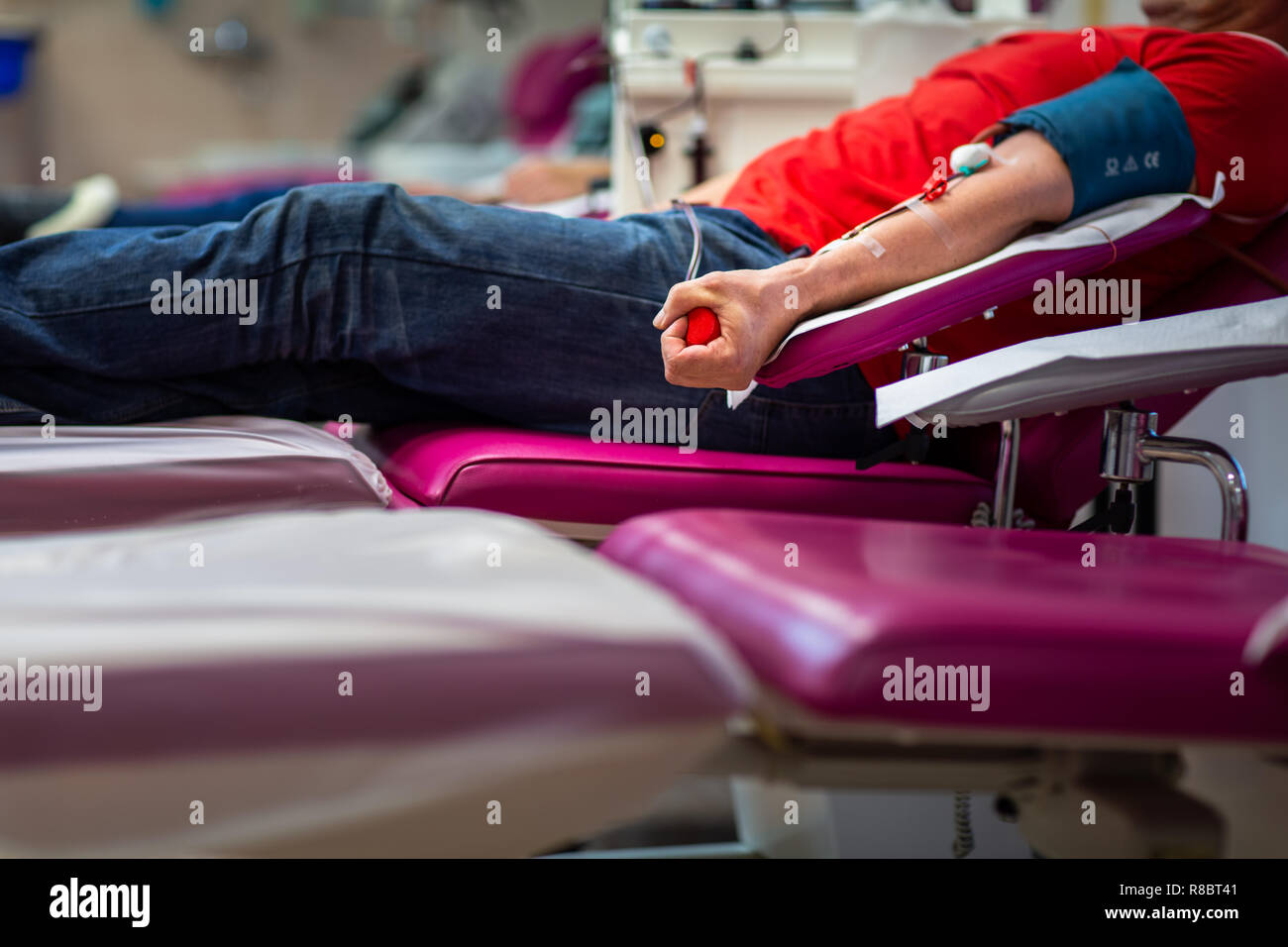 Young woman giving blood in a modern hospital Stock Photo - Alamy