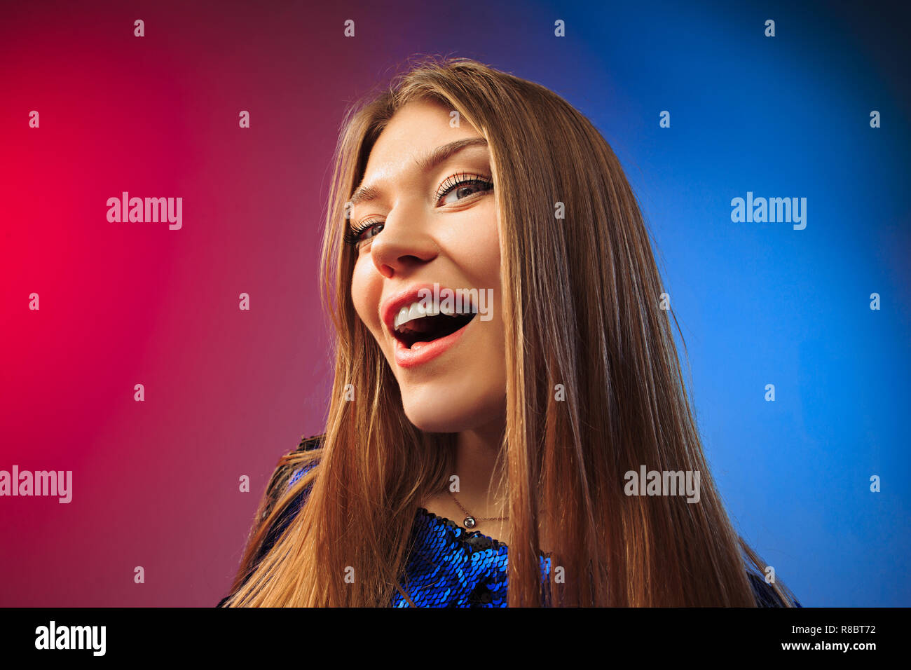 Happy woman standing, smiling on colored studio background. Beautiful ...