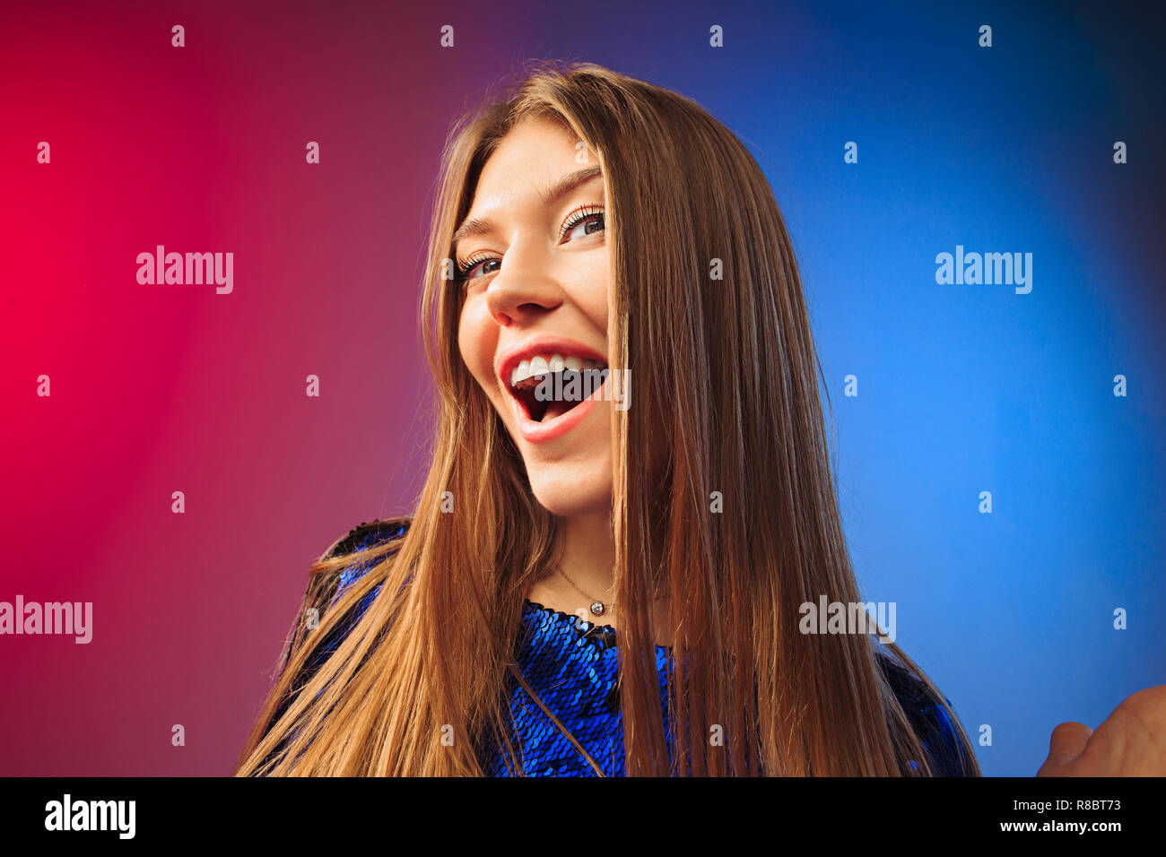 Happy woman standing, smiling on colored studio background. Beautiful ...