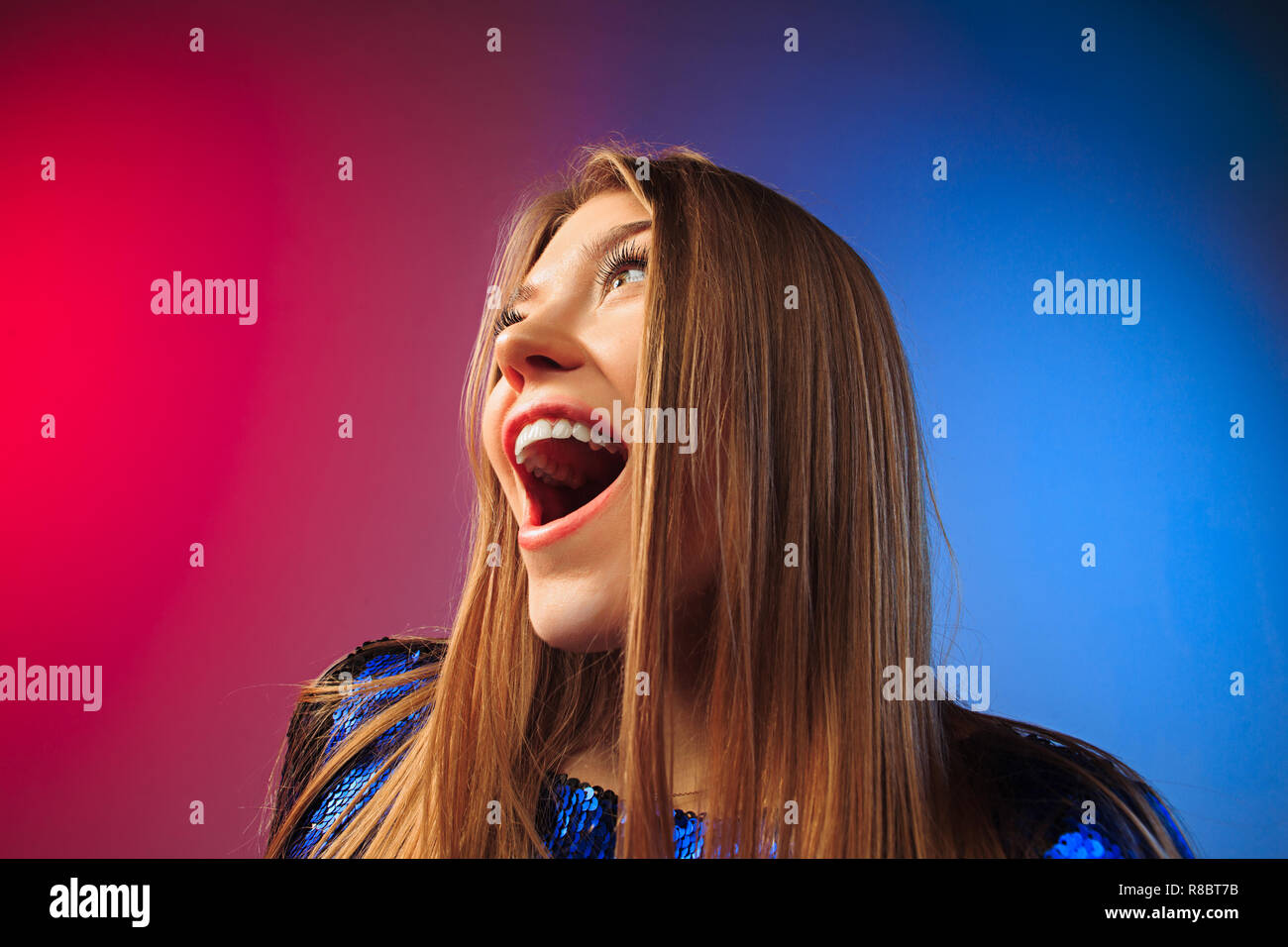 Happy woman standing, smiling on colored studio background. Beautiful ...