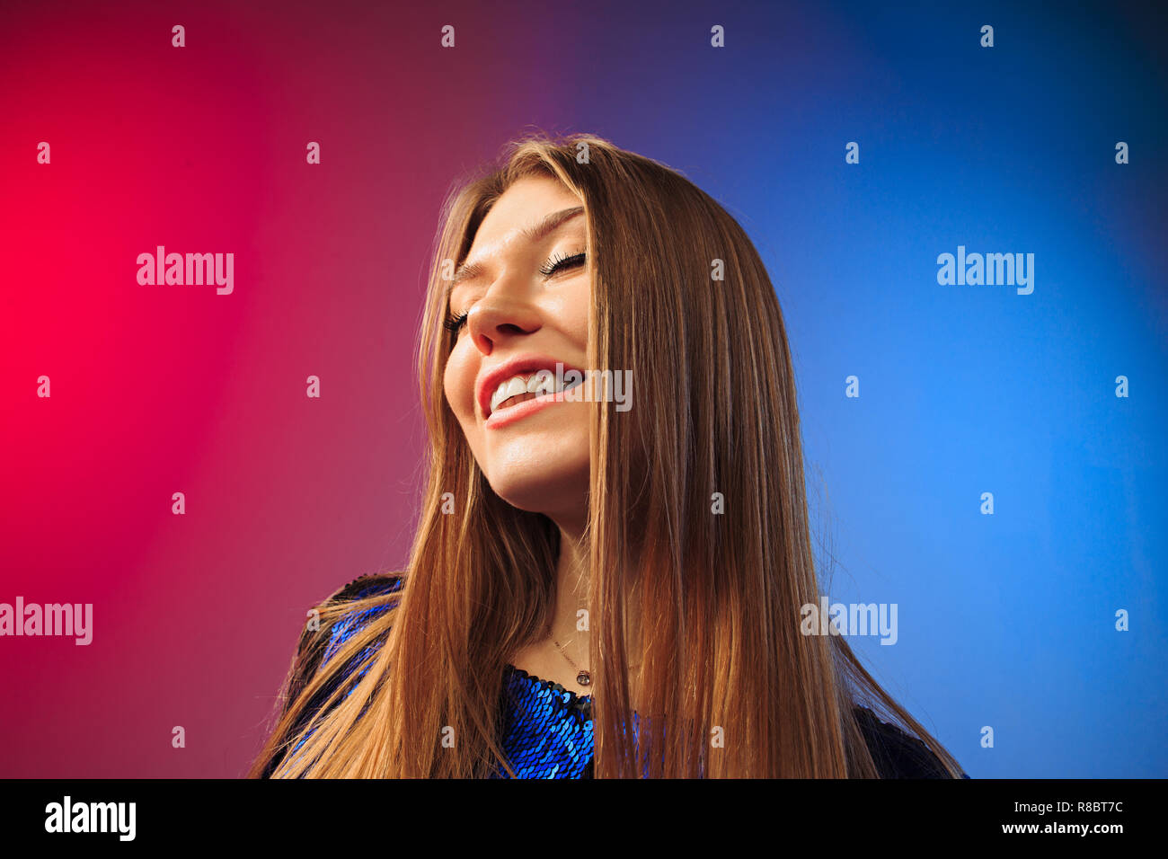 Happy woman standing, smiling on colored studio background. Beautiful ...