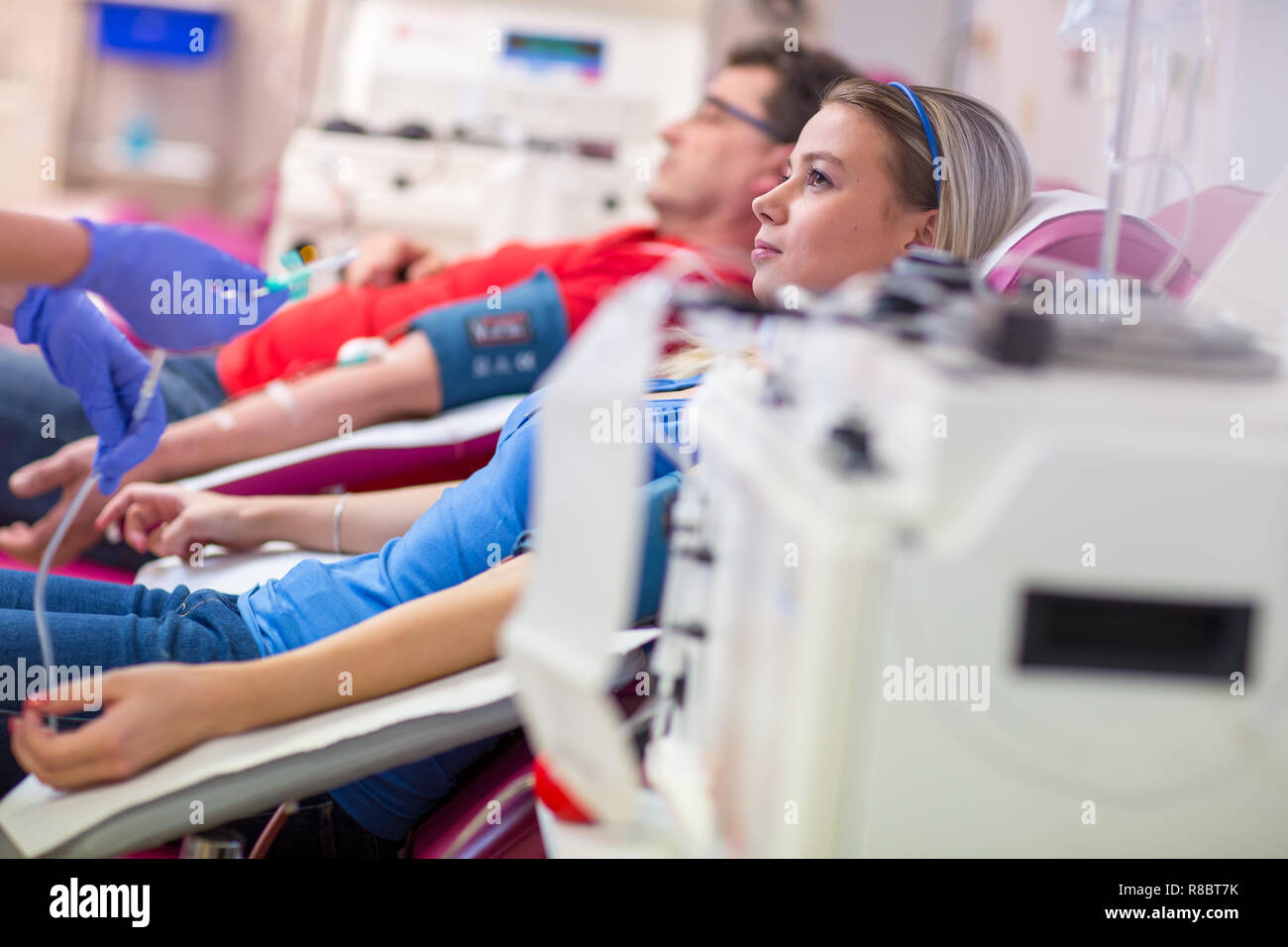 Young woman giving blood in a modern hospital Stock Photo - Alamy