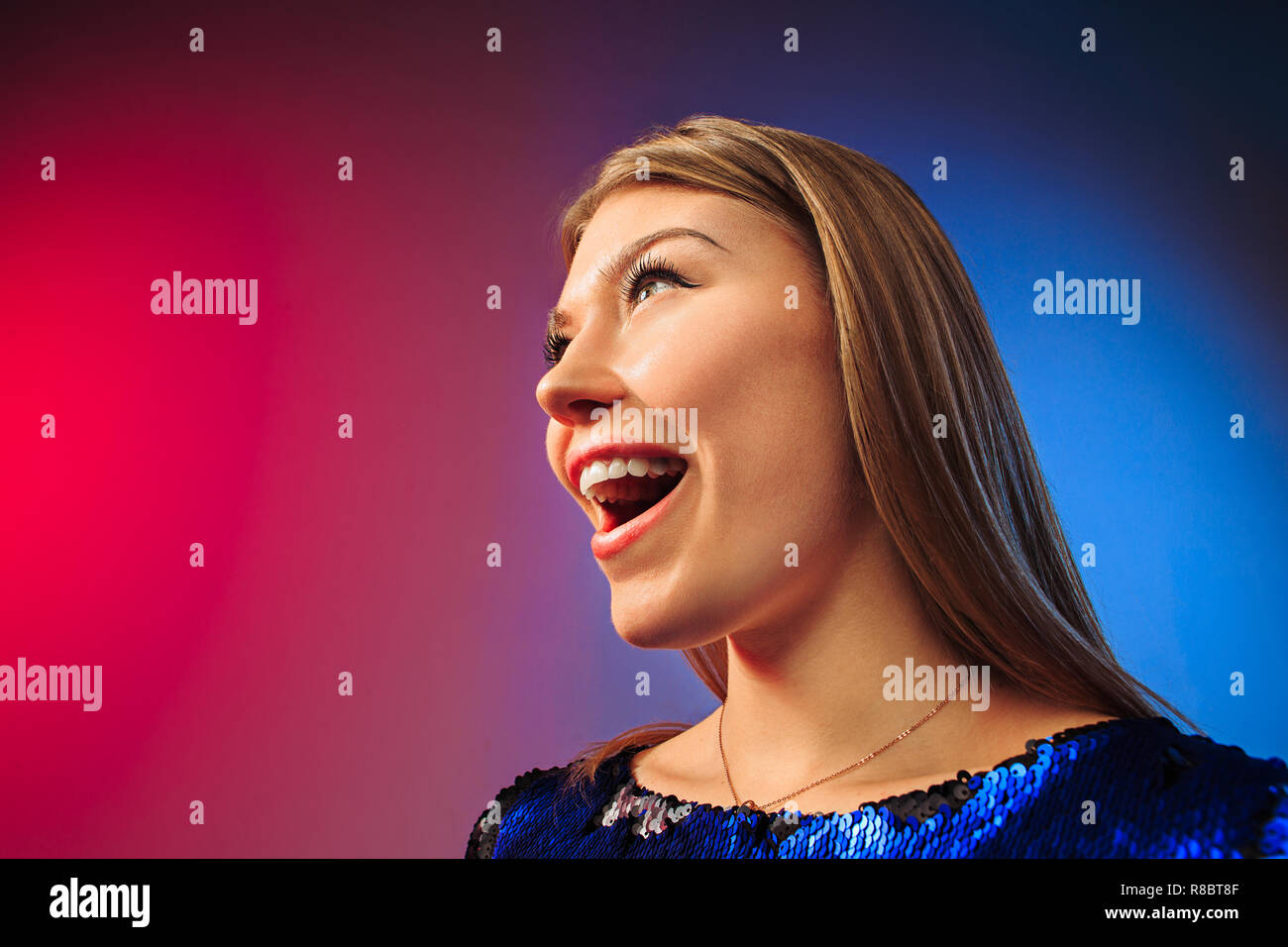 Happy woman standing, smiling on colored studio background. Beautiful ...