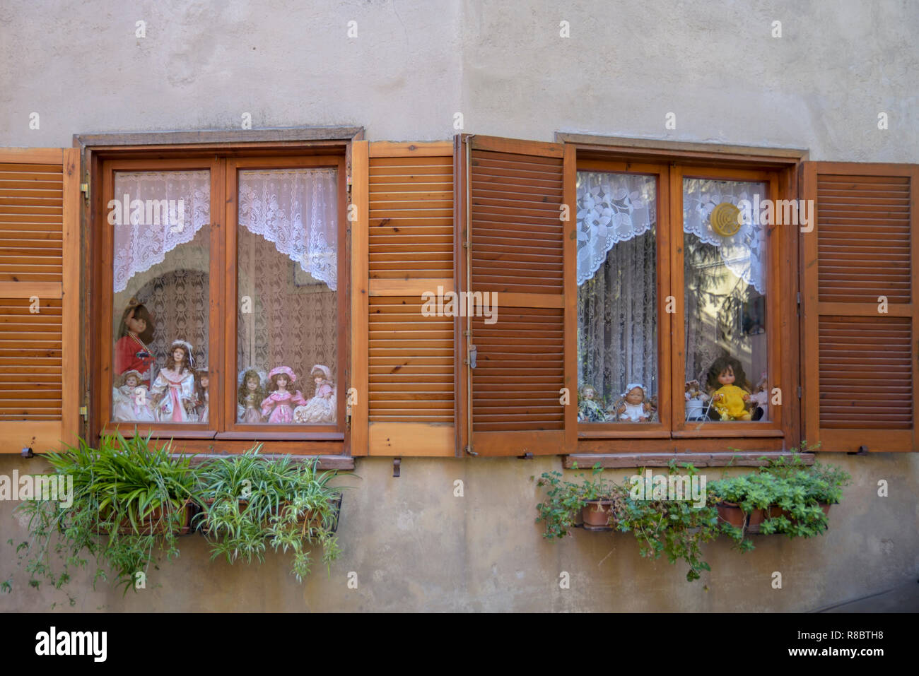 windows with dolls on the windowsill Stock Photo - Alamy