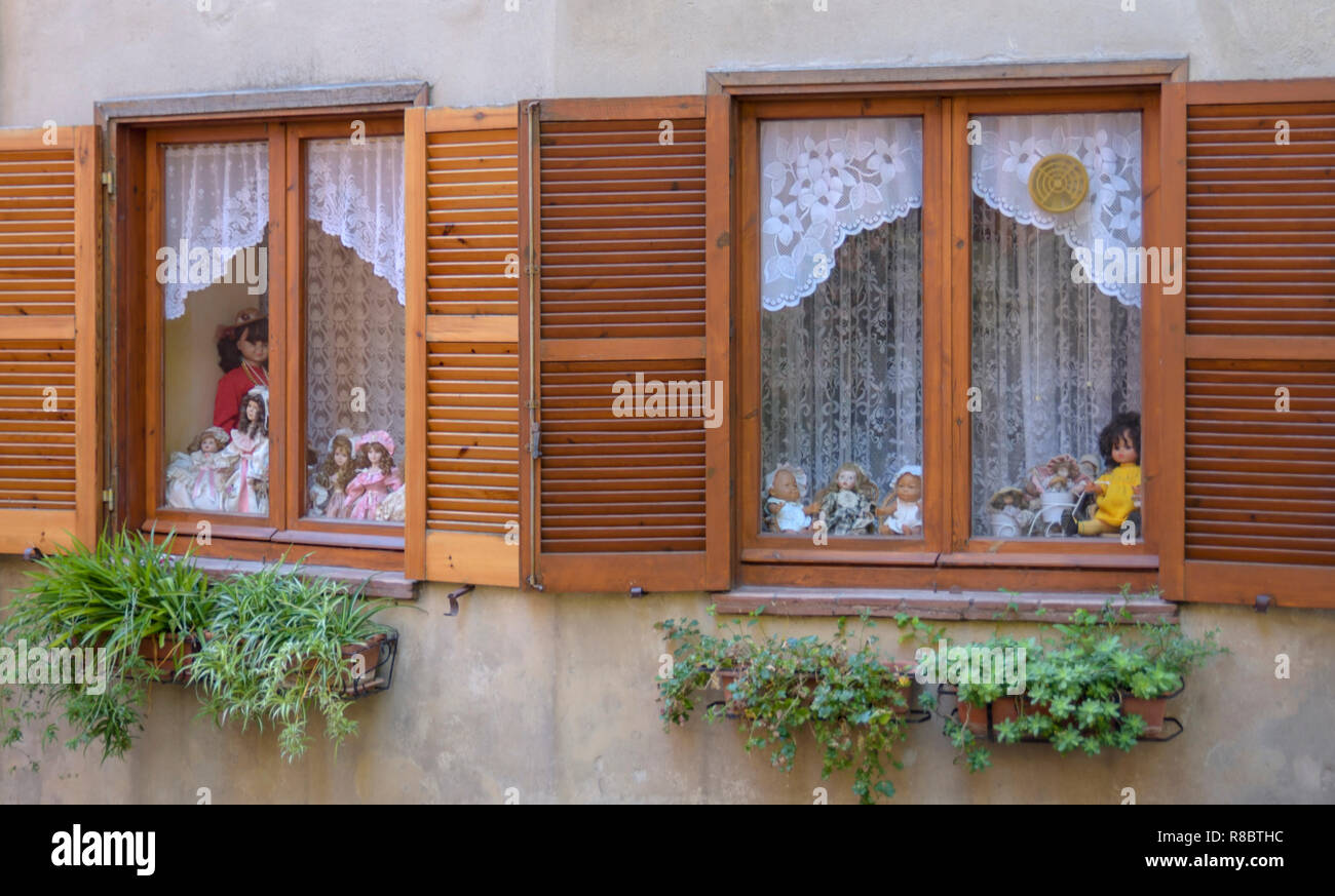 windows with dolls on the windowsill Stock Photo - Alamy