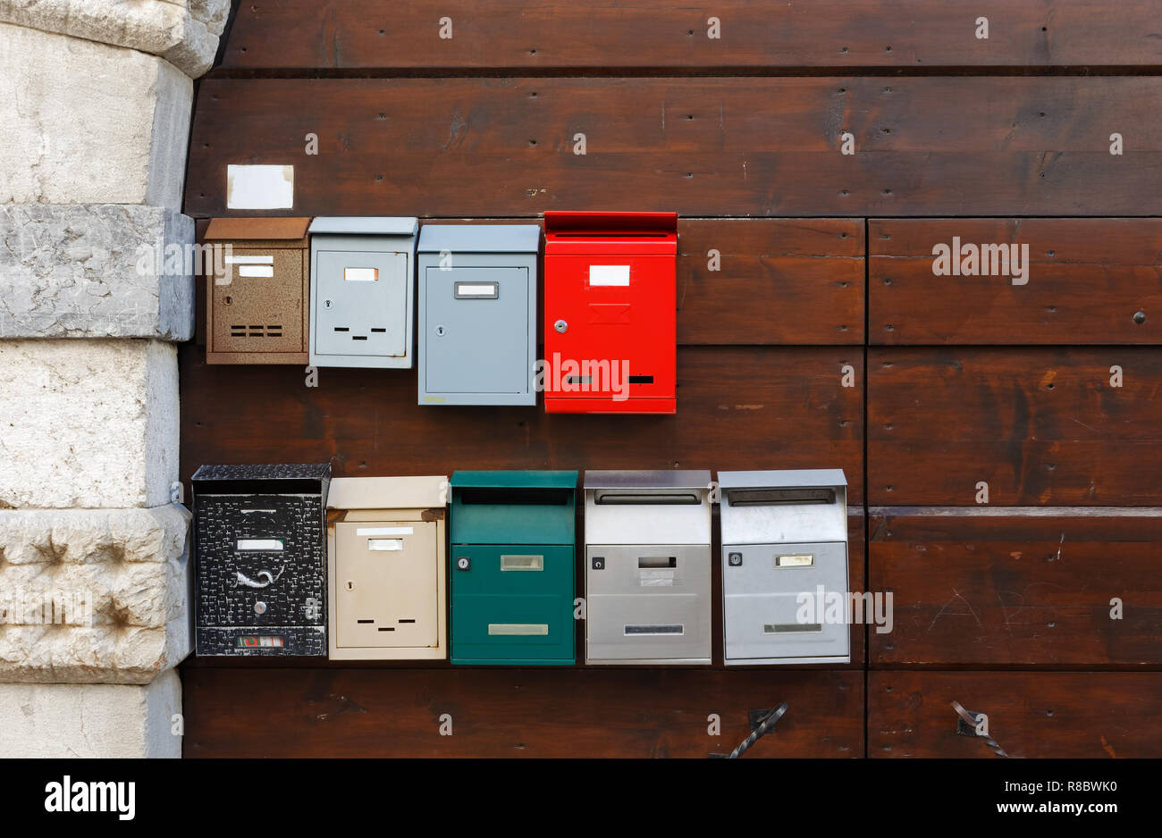 Two rows of mailboxes on the wooden gate of a traditional house Stock ...
