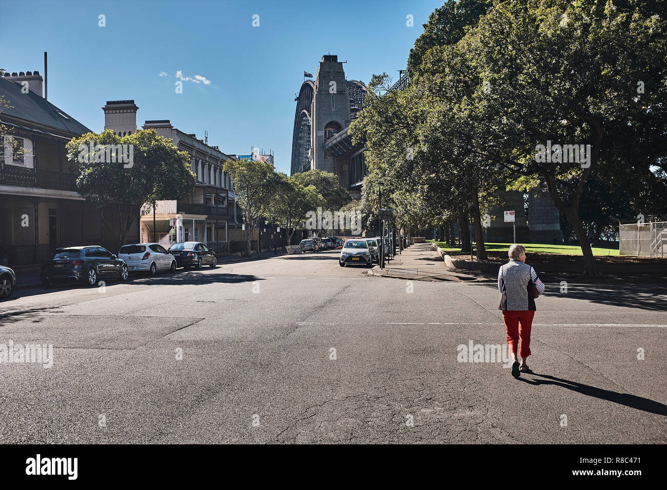 A women on her own walking along Lower Fort Street with the Sydney ...