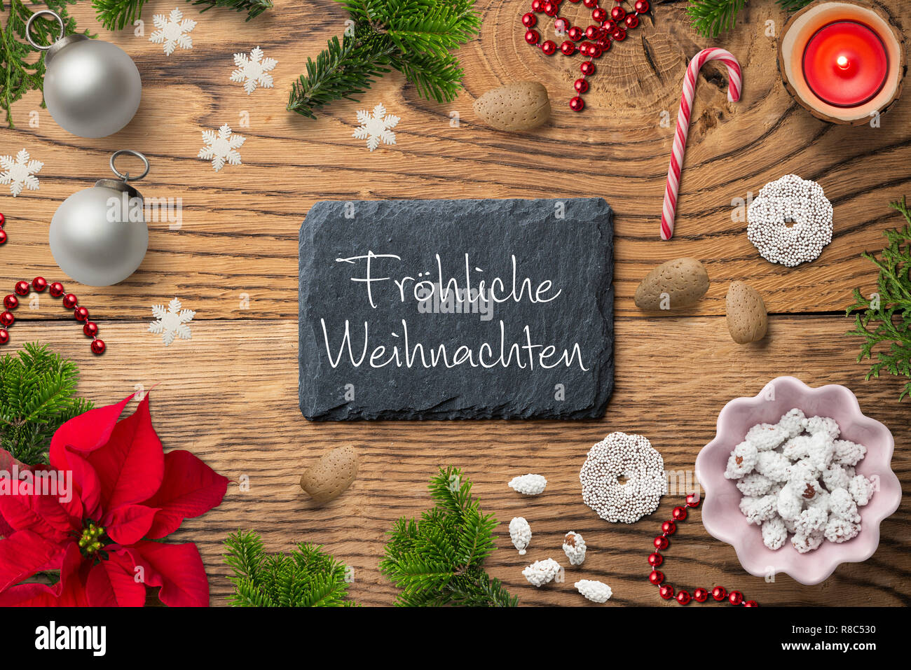 Christmas decoration on rustic wooden background and the German message ...