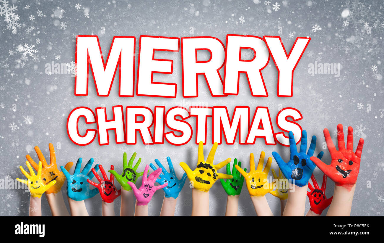 painted children hands with smiley in front of christmas background ...