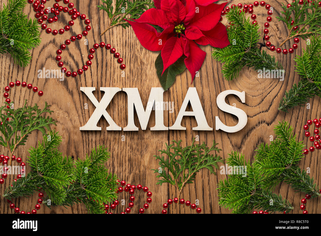 Christmas decoration on rustic wooden background and the message "XMAS ...