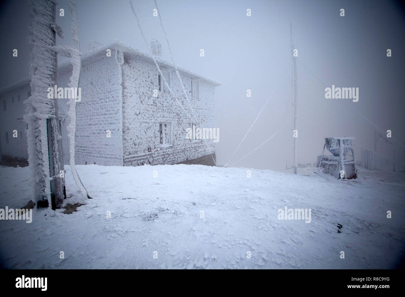 Frozen lonely house in the middle of nowhere in the winter. Heavy fog ...