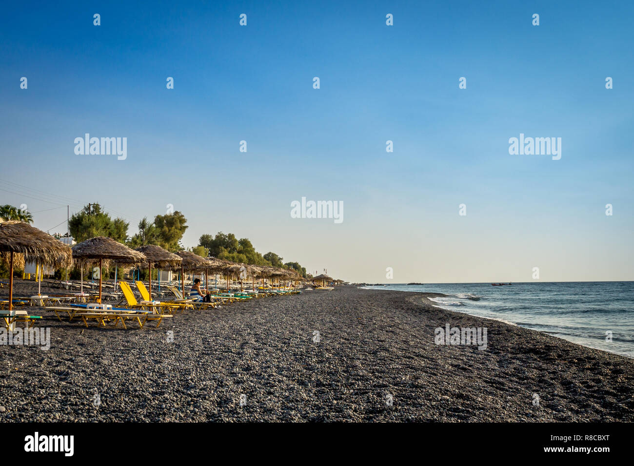 Early morning on Kamari beach in Santorini. Blue sky nice weather ...