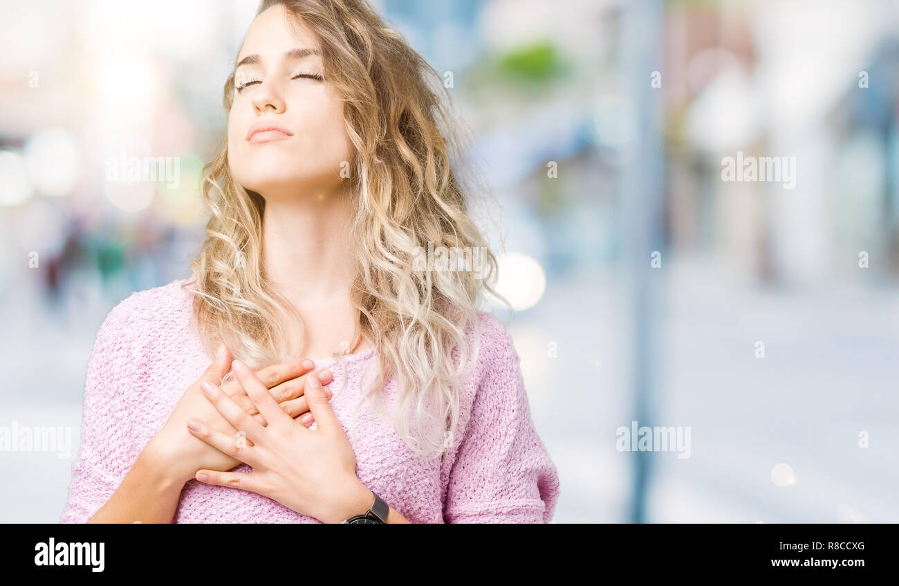 Beautiful young blonde woman over isolated background smiling with ...